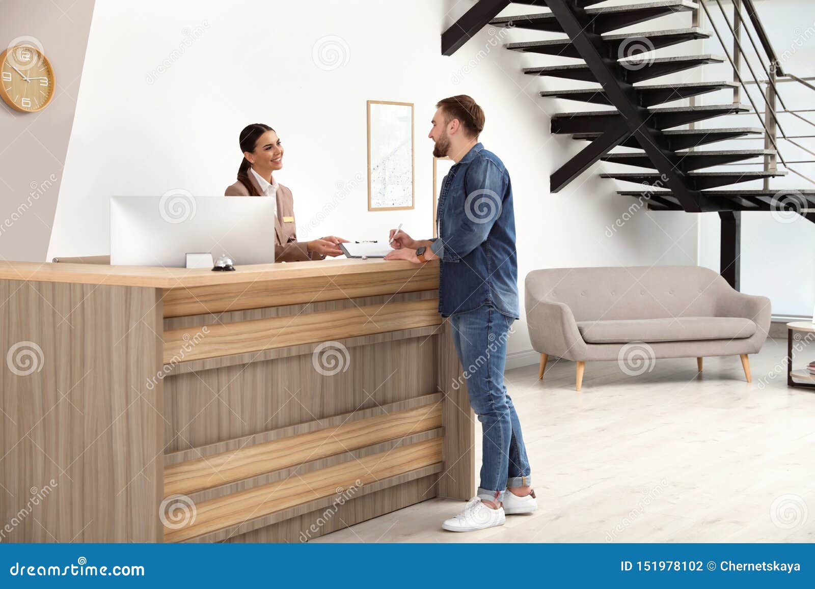 Professional Receptionist Working with Client at Desk in Hotel Stock ...