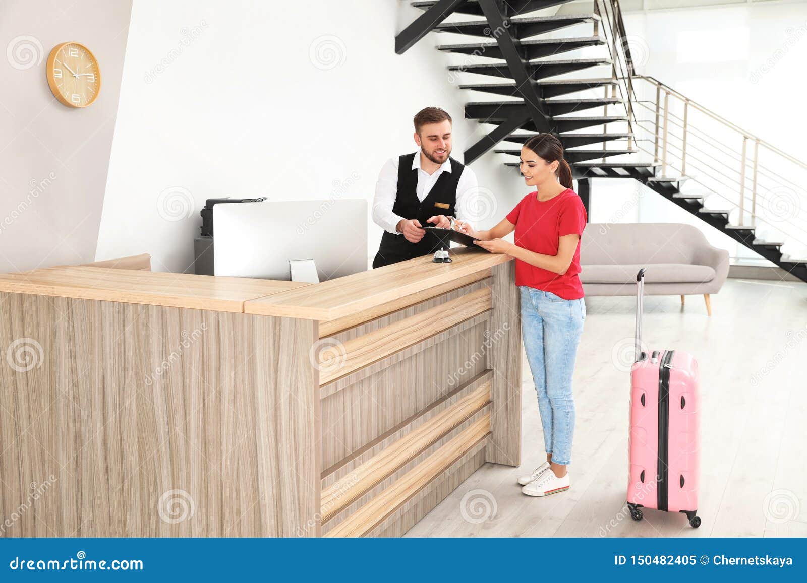 Professional Receptionist Working with Client at Desk in Hotel Stock ...