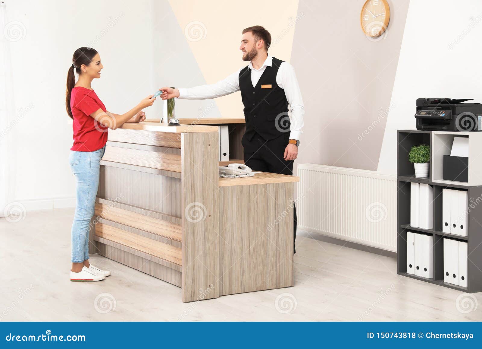 Professional Receptionist Working with Client at Desk Stock Photo ...