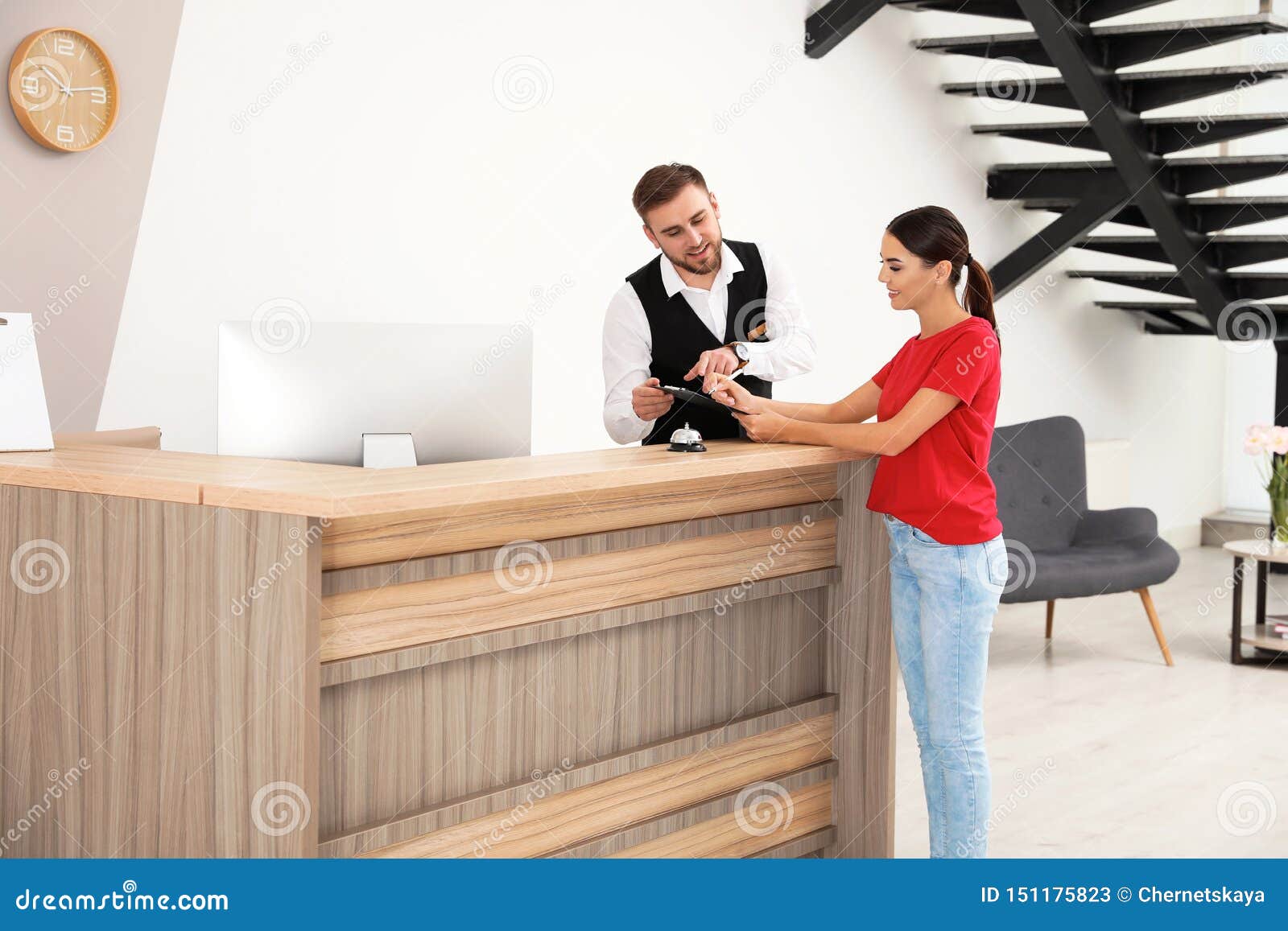 Professional Receptionist Working with Client at Desk Stock Image ...