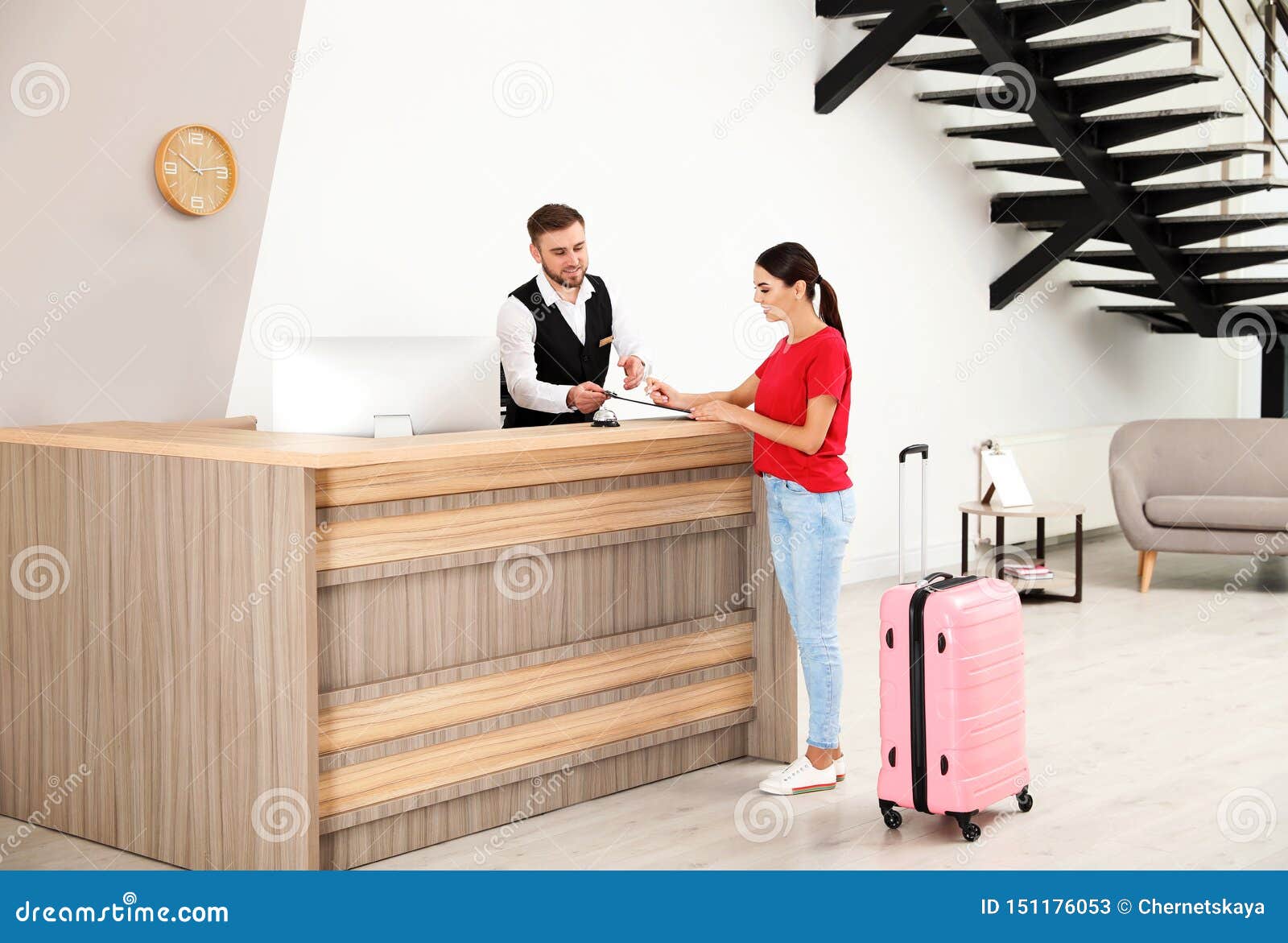 Professional Receptionist Working with Client at Desk Stock Image ...