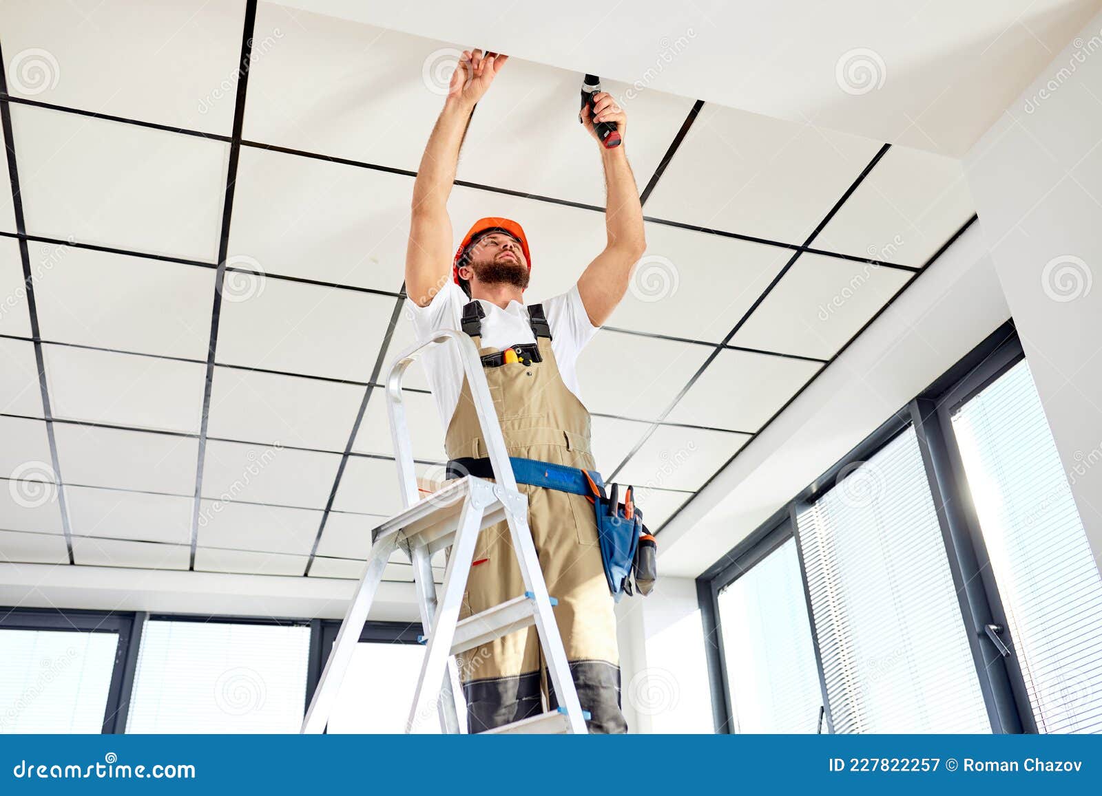 Professional Repairman Contractor Working on Overhead Ceiling Panel ...