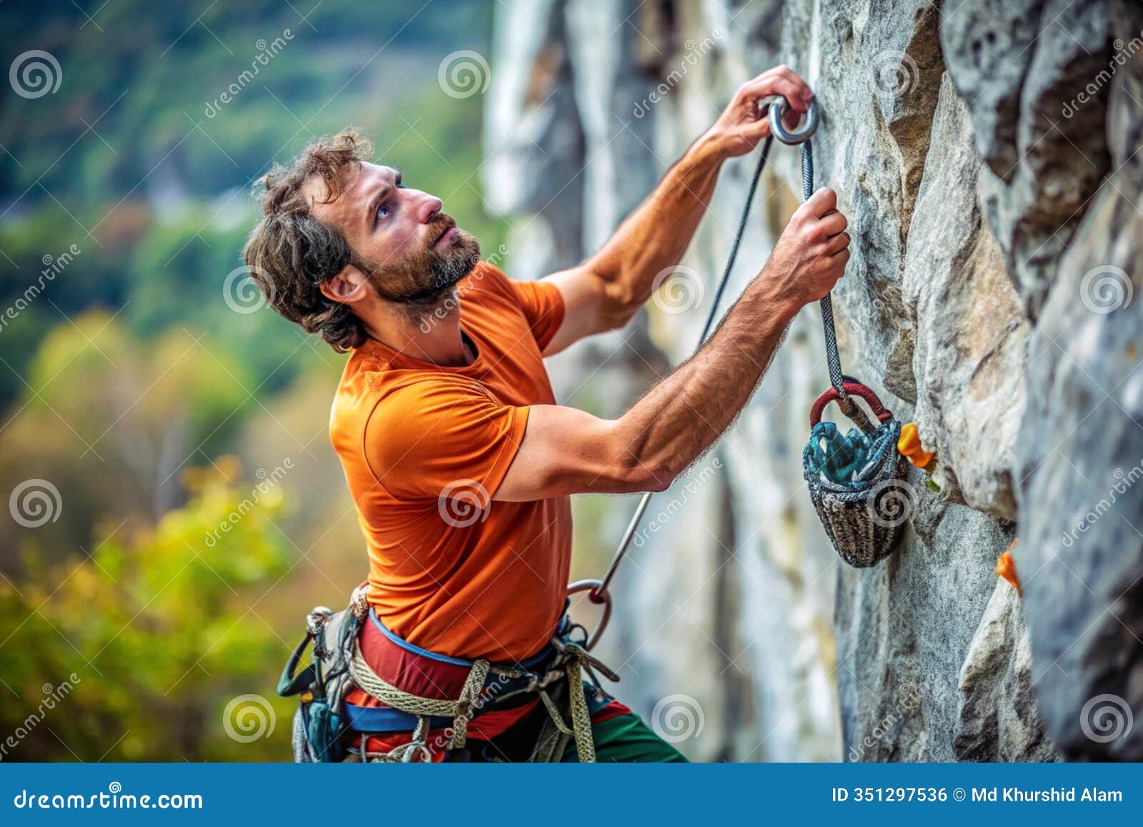 Professional Rock Climber Securing Ropes during a Climb on a Steep ...