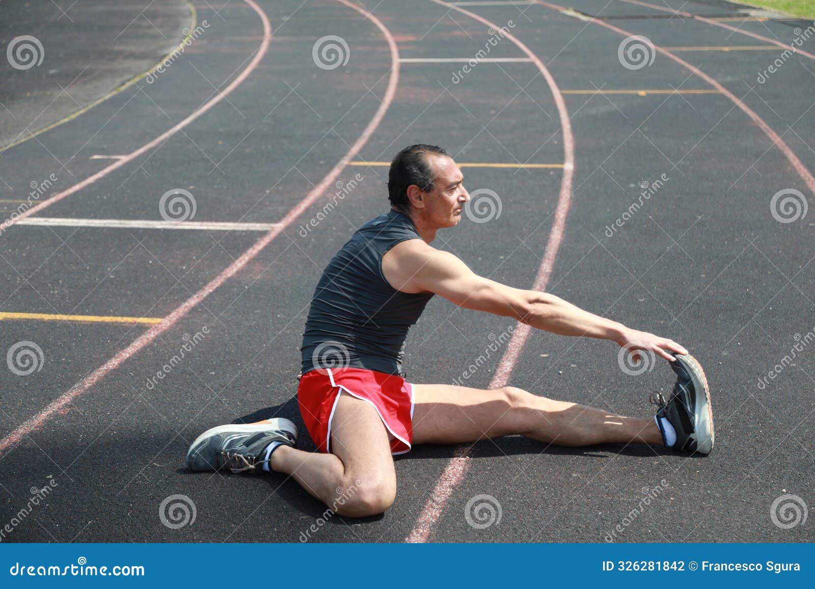 Athlete on a Racing Track Stretching after the Run Stock Photo - Image ...