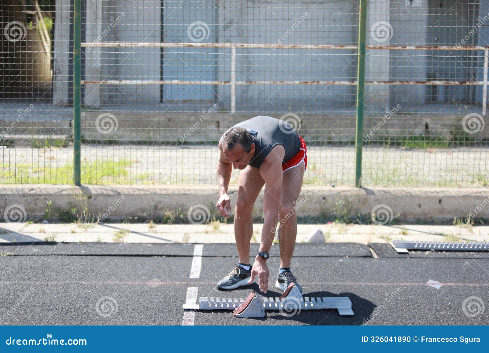 Runner Setting the Starting Blocks on the Track Stock Photo - Image of ...