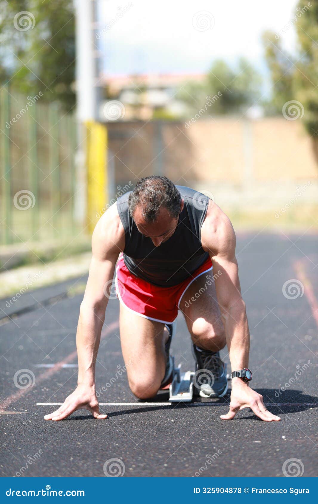 Runner on the Starting Blocks in Position Stock Photo - Image of energy ...