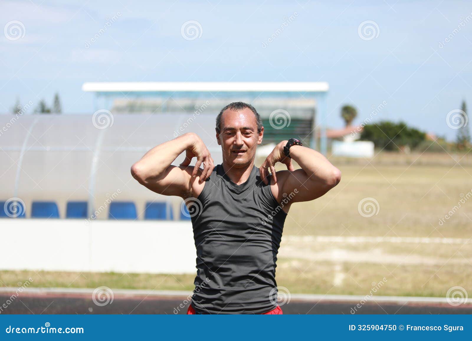 Sweating and Stretching Athlete at the Stadium Stock Photo - Image of ...
