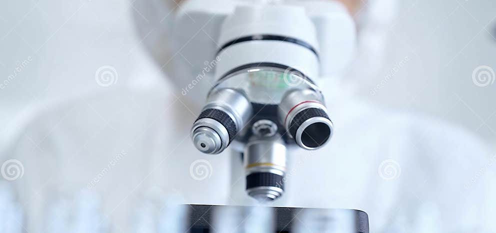 Professional Scientist in Protective Gear is Using Microscope in a ...