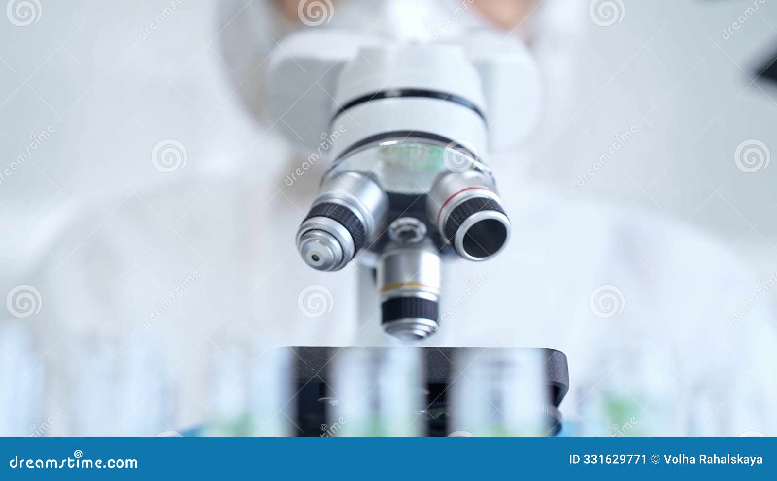 Professional Scientist in Protective Gear is Using Microscope in a ...
