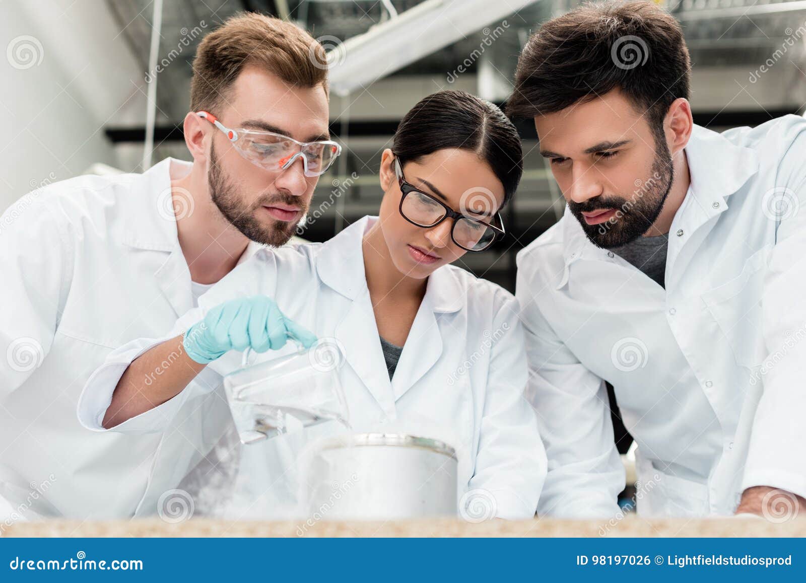 Professional Scientists in Lab Coats Making Chemical Experiment ...