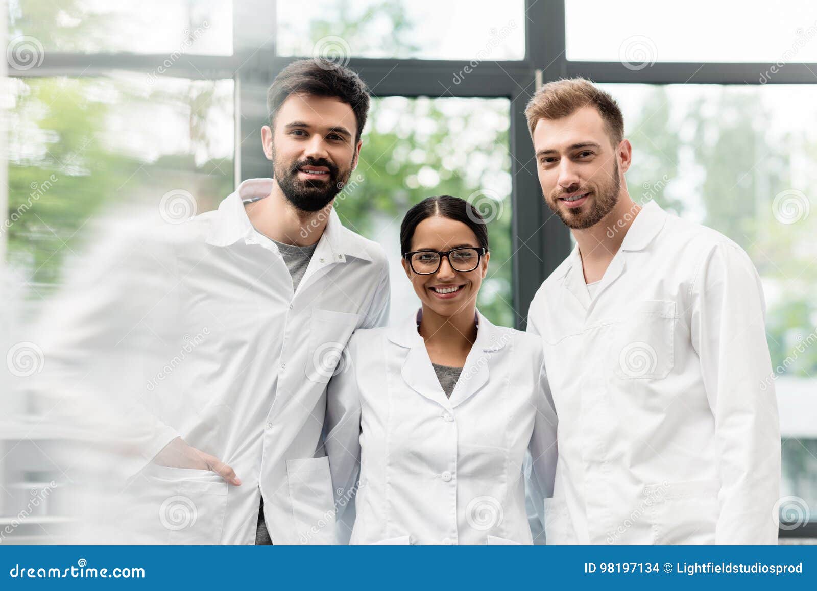 Professional Scientists in White Coats Standing Together and Smiling at ...