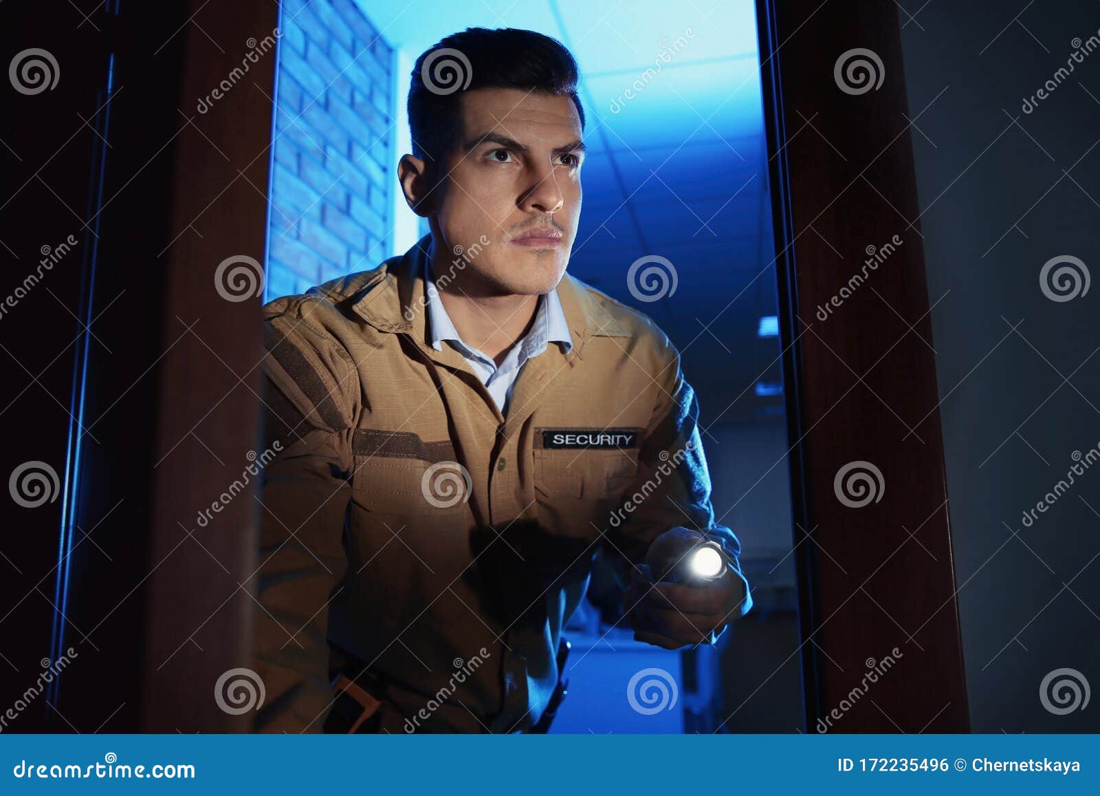 Professional Security Guard with Flashlight Checking Room Stock Photo ...
