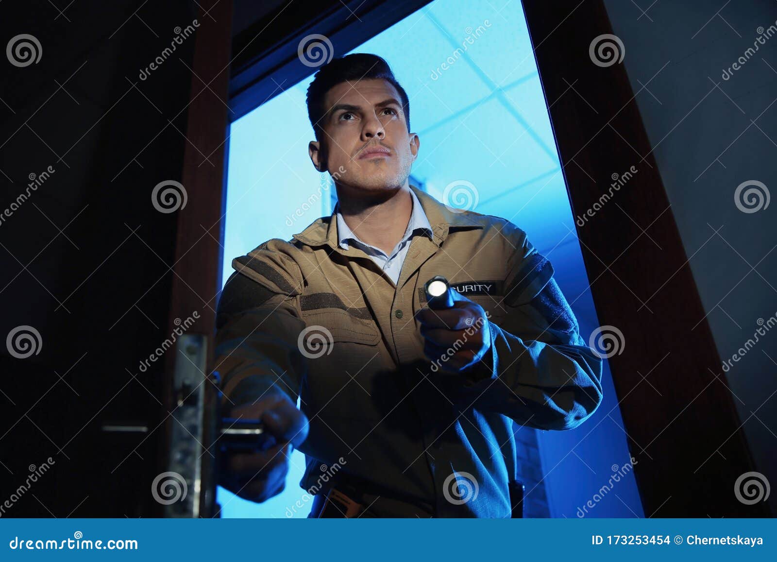 Professional Security Guard with Flashlight Checking Room Stock Photo ...