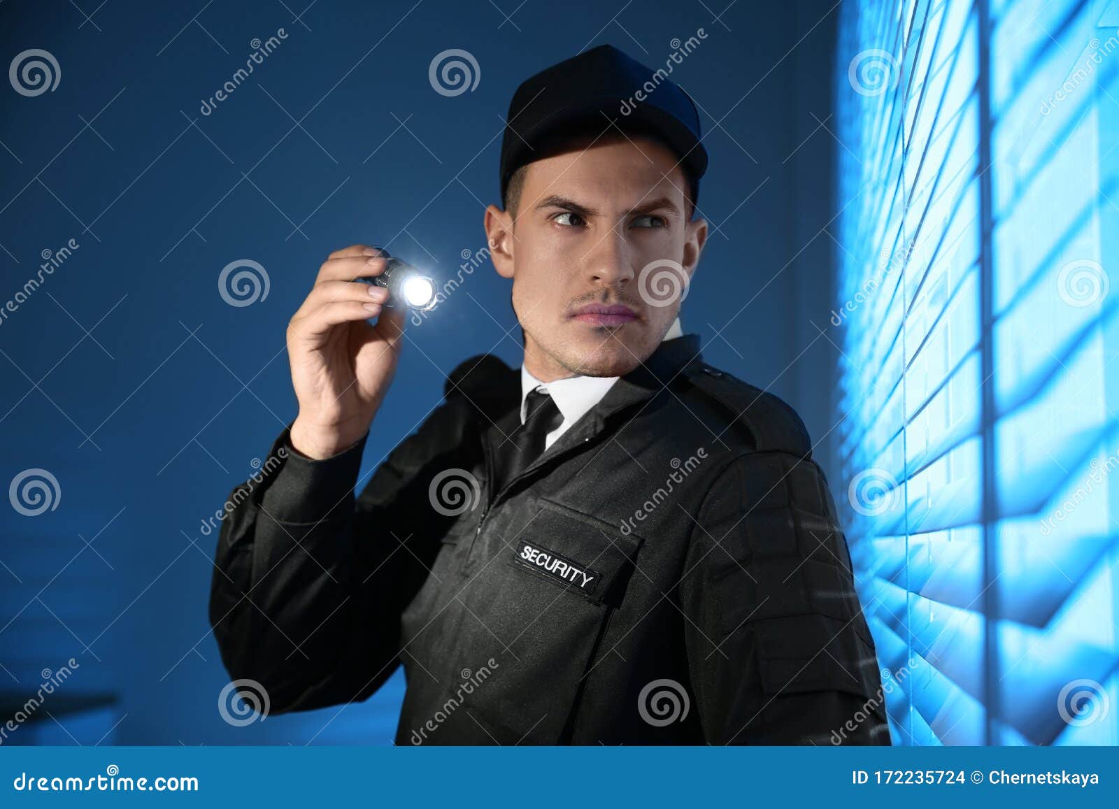 Professional Security Guard with Flashlight Near Window in Room Stock ...