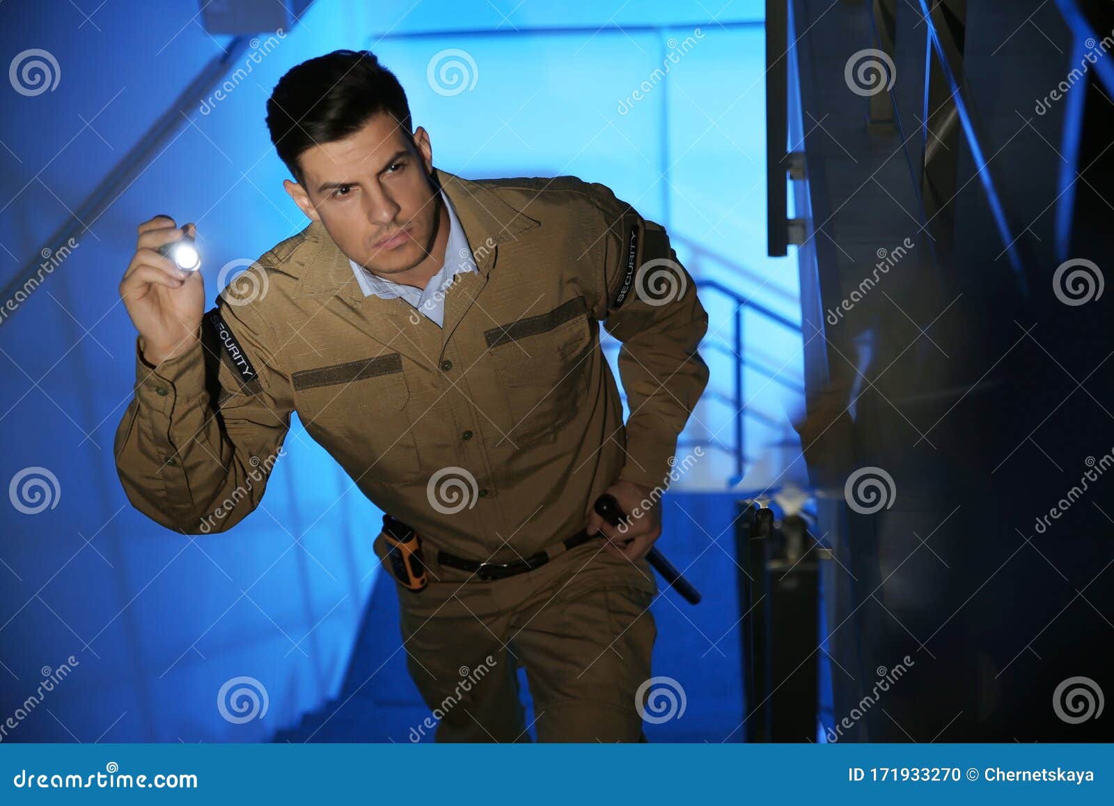 Professional Security Guard with Flashlight on Stairs in Room Stock ...