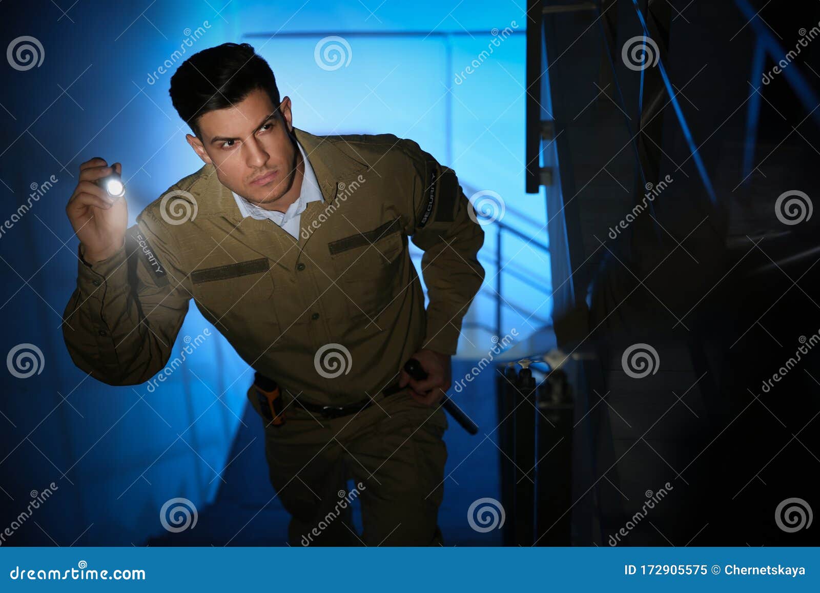 Professional Security Guard with Flashlight on Stairs in Room Stock ...