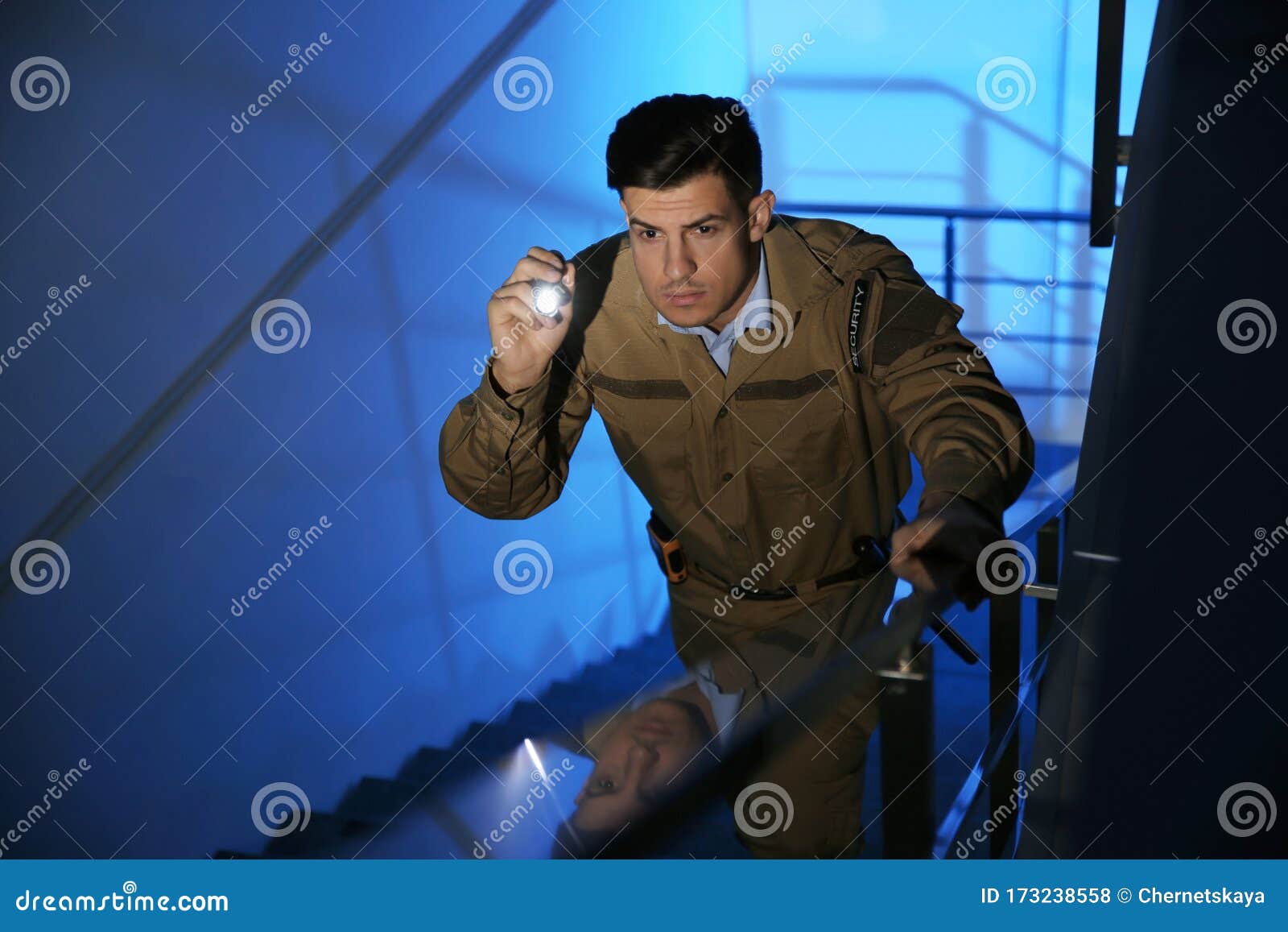Professional Security Guard with Flashlight on Stairs in Room Stock ...