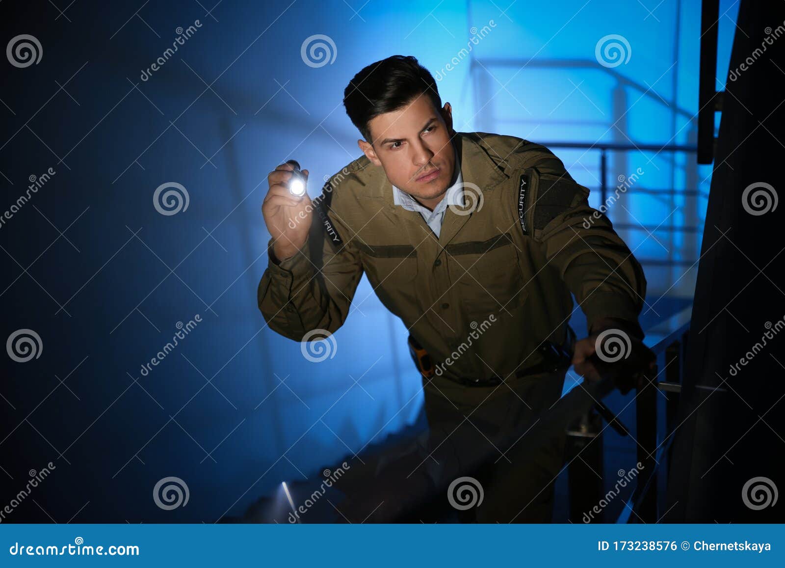 Professional Security Guard with Flashlight on Stairs in Room Stock ...