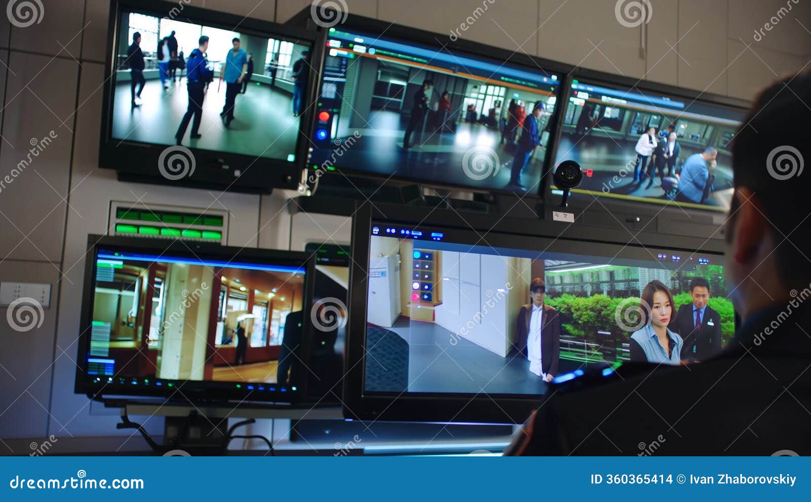 Security Professional Watching Multiple Surveillance Monitors, Tracking ...
