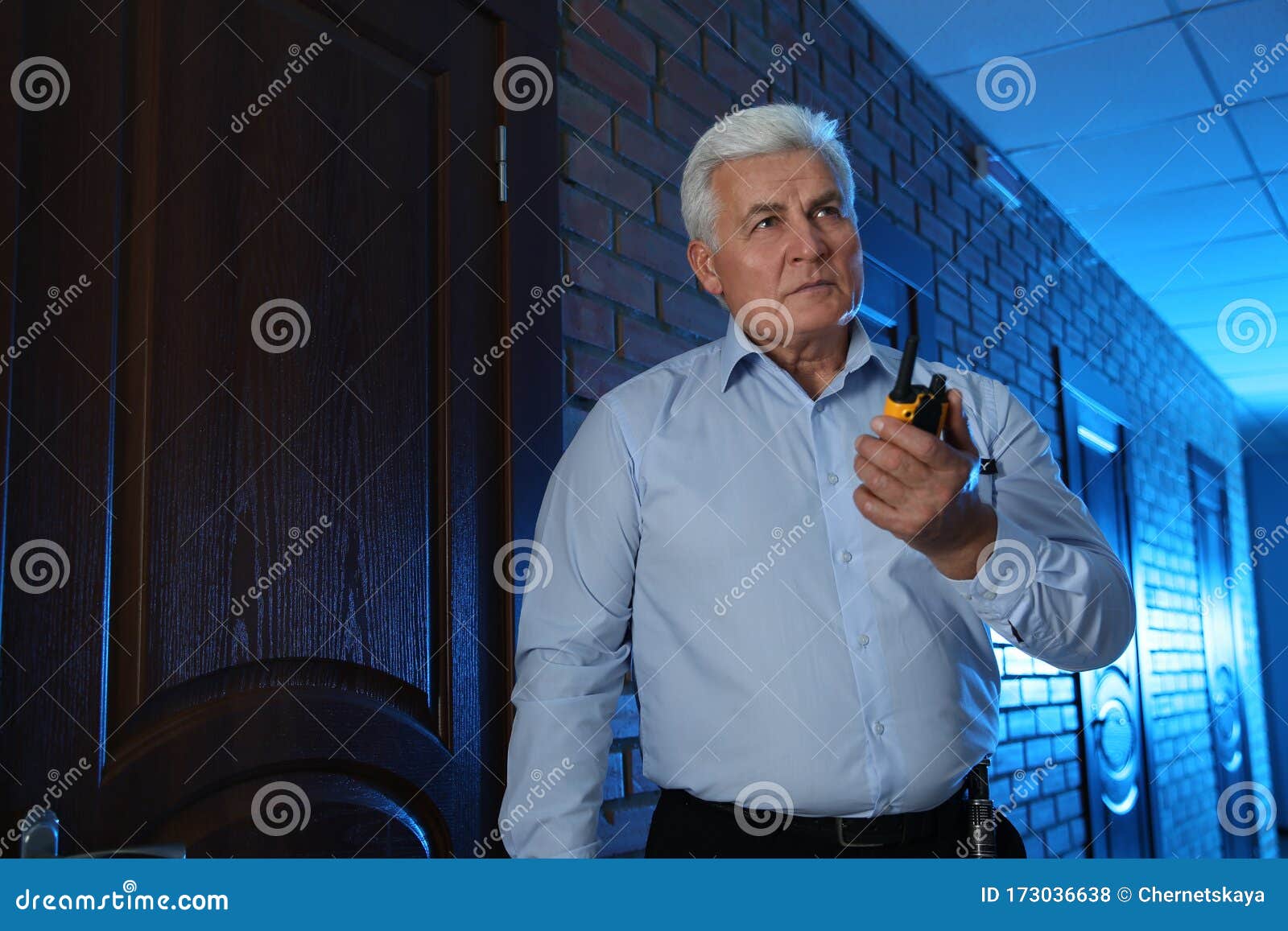 Professional Security Guard with Portable Radio Set in Hallway Stock ...