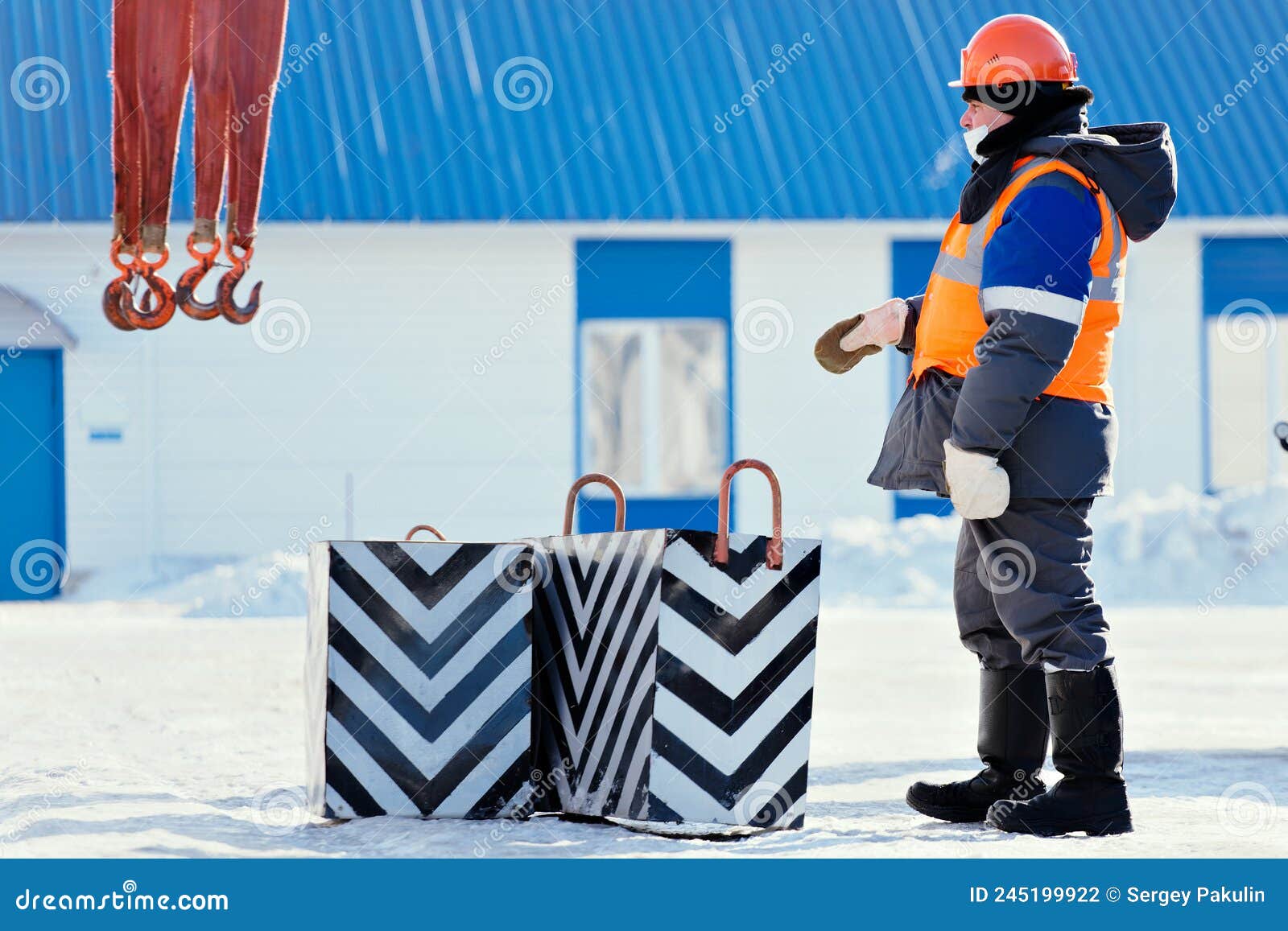 Slinger In Helmet And Vest Unloads Metal Pipes And Fittings From Truck ...