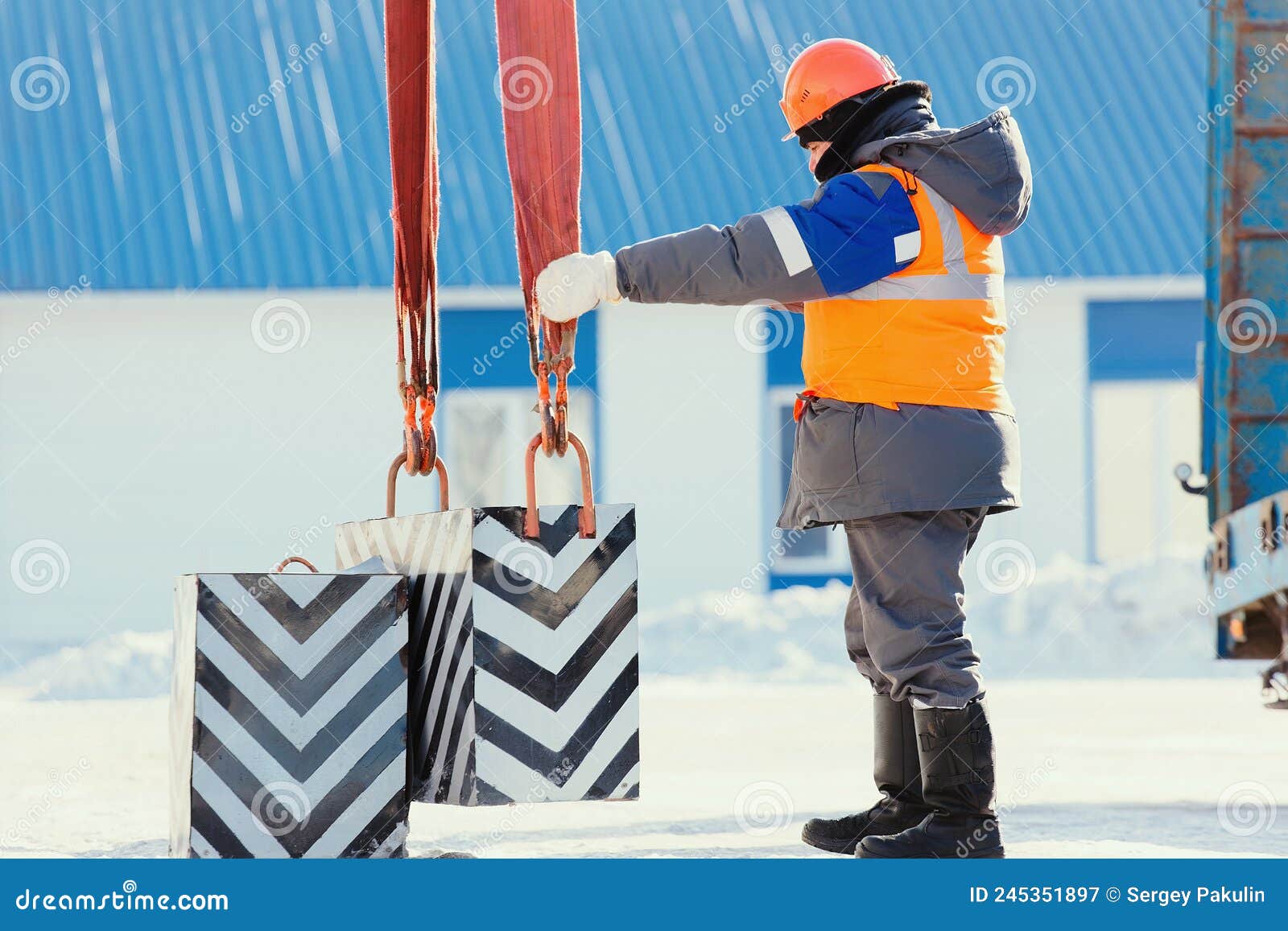 Professional Slinger in Construction Helmet at Factory Unloads Cargo ...