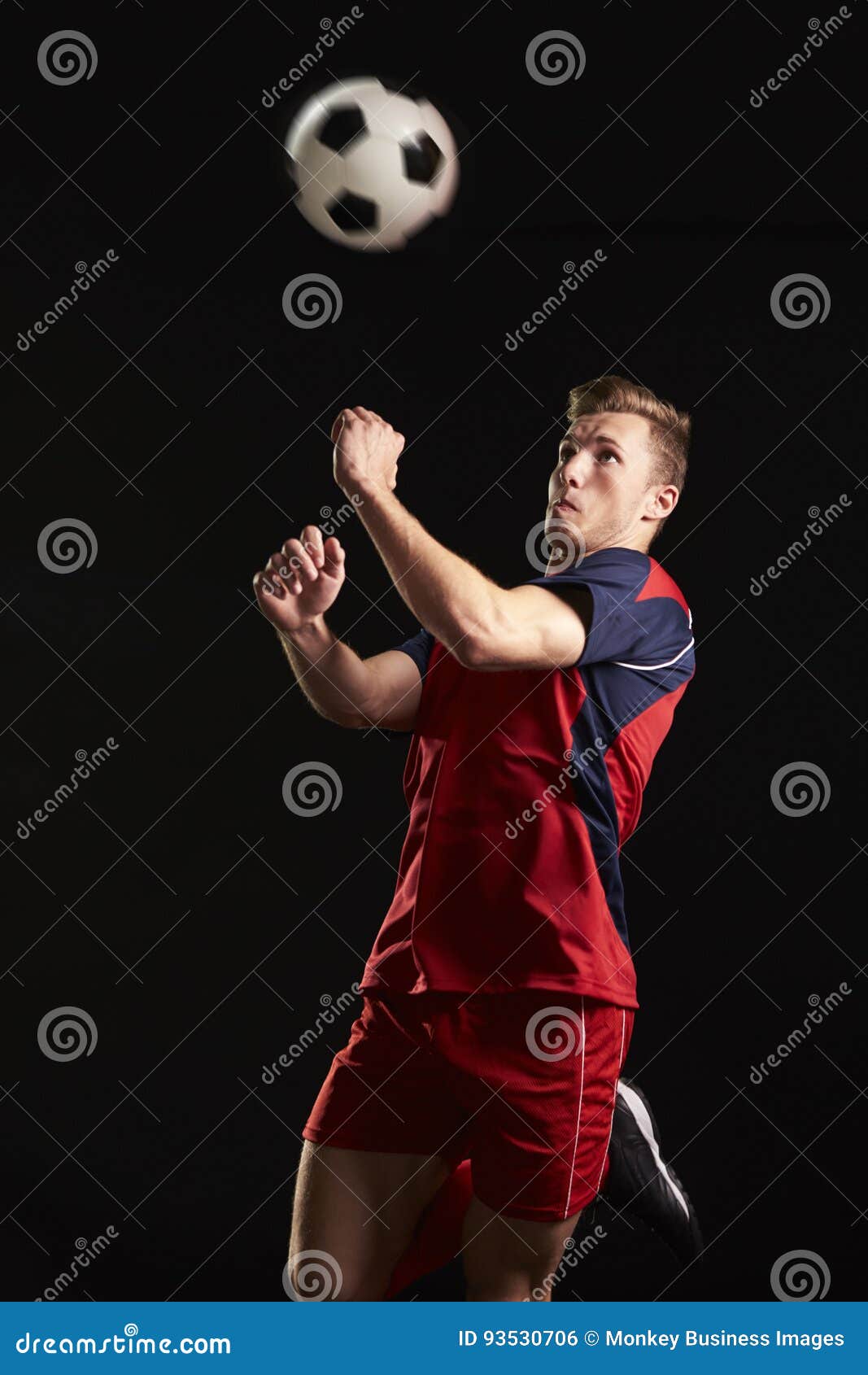 Professional Soccer Player Jumping To Head Ball in Studio Stock Photo ...