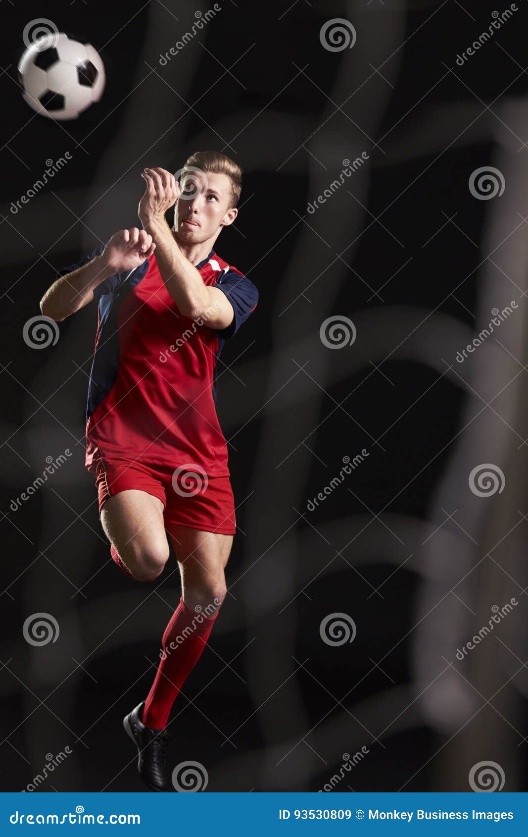 Professional Soccer Player Jumping To Head Ball in Studio Stock Image ...