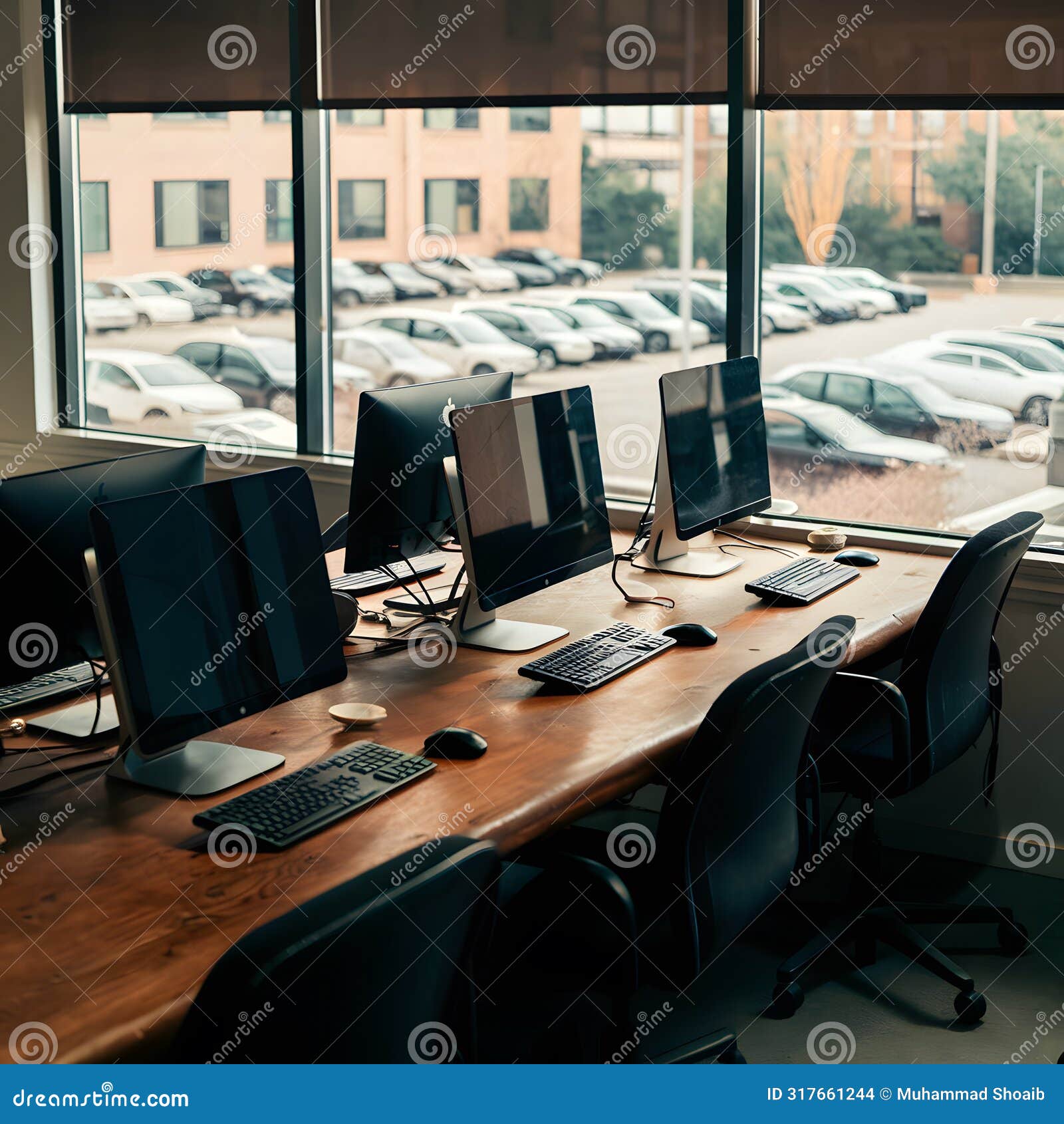 Professional, Spacious Office Setup With Three Monitors, Keyboards, Mice, And Large Windows ...