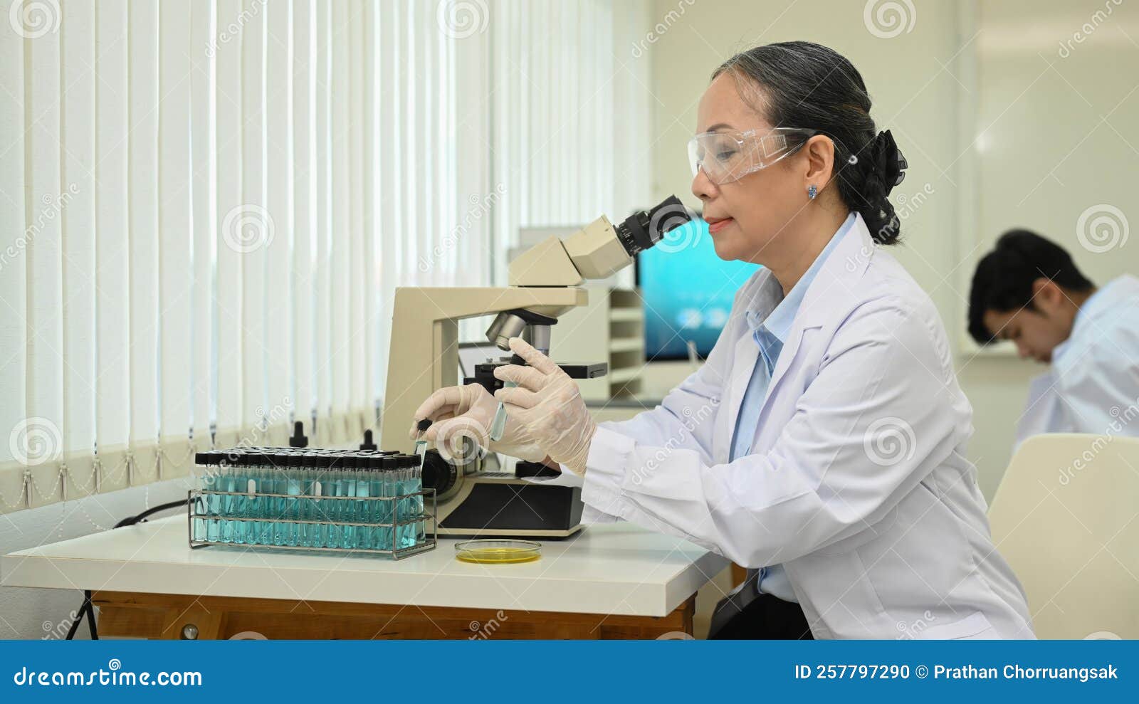 Professional Specialist Looking Under Microscope, Conducting Experiment ...