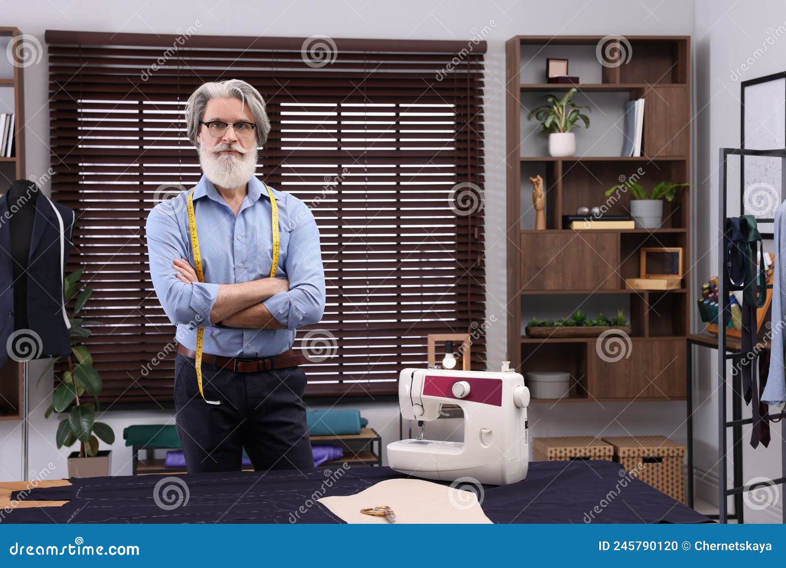 Professional Tailor with Measuring Tape Near Table in Workshop Stock ...