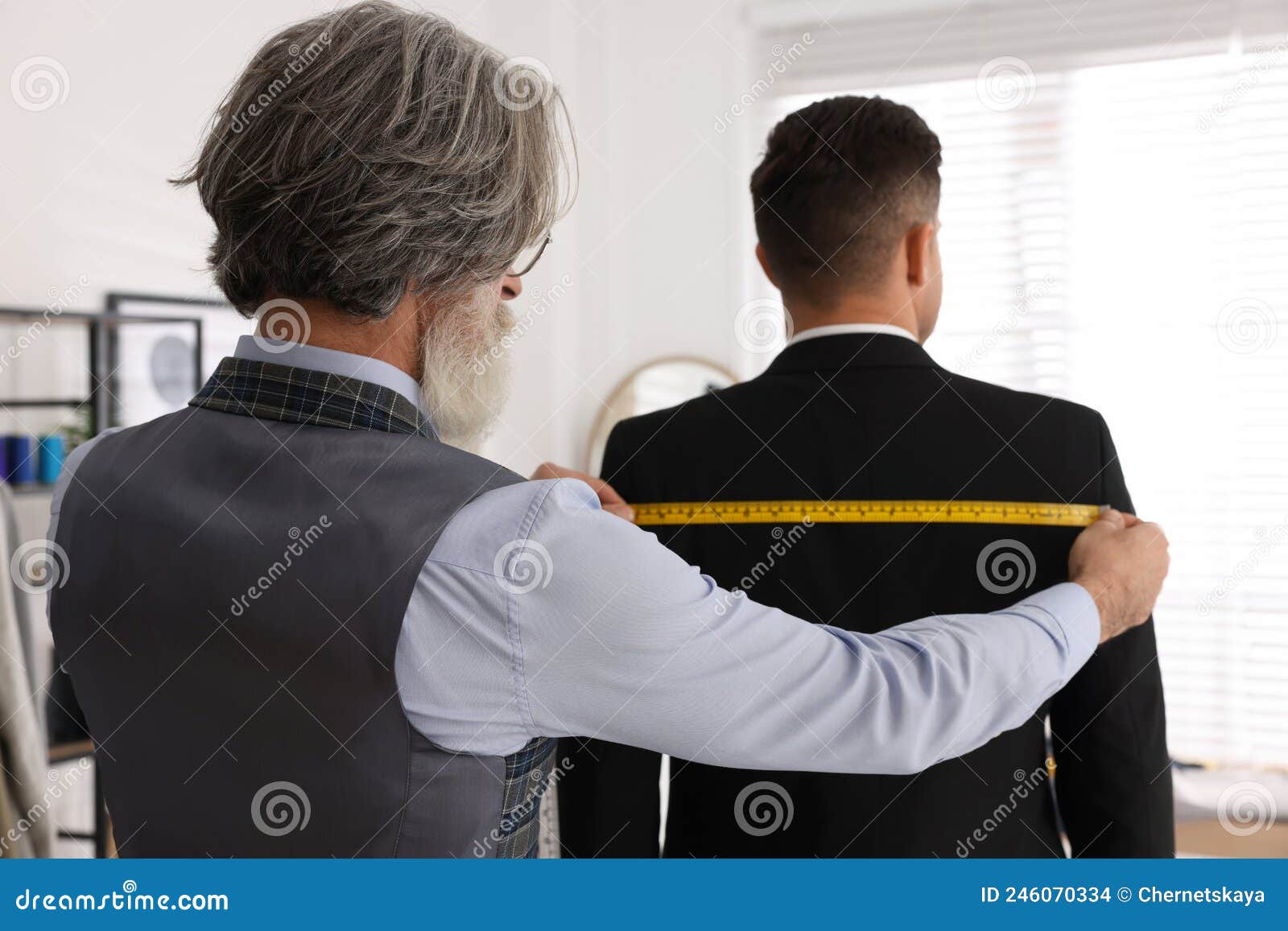 Professional Tailor Working with Client in Atelier, Back View Stock ...