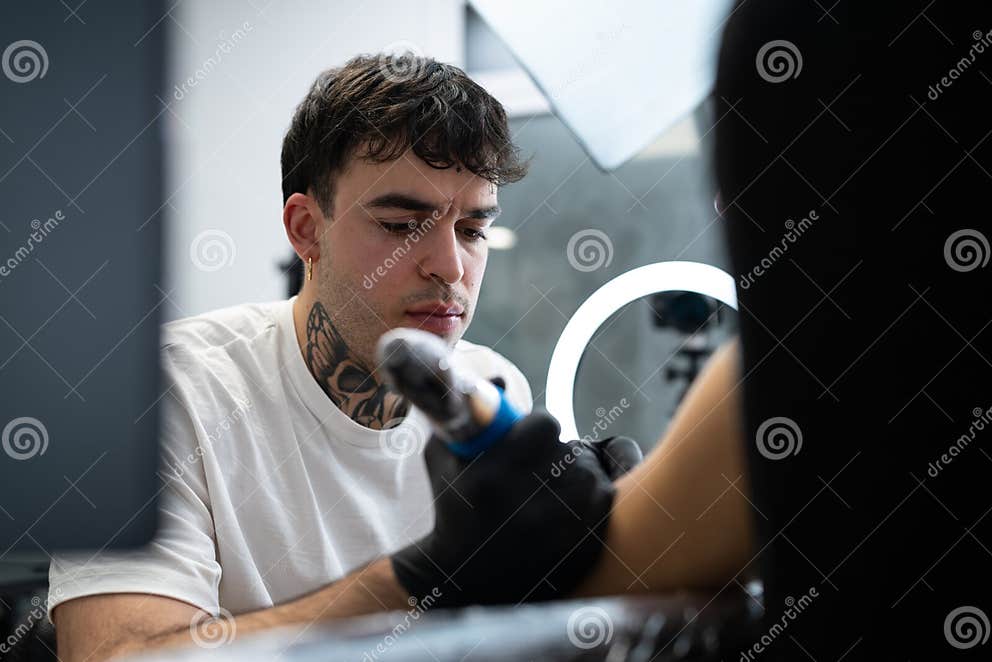 Professional Tattoo Artist with Focus and Precision, Applying a Tattoo ...