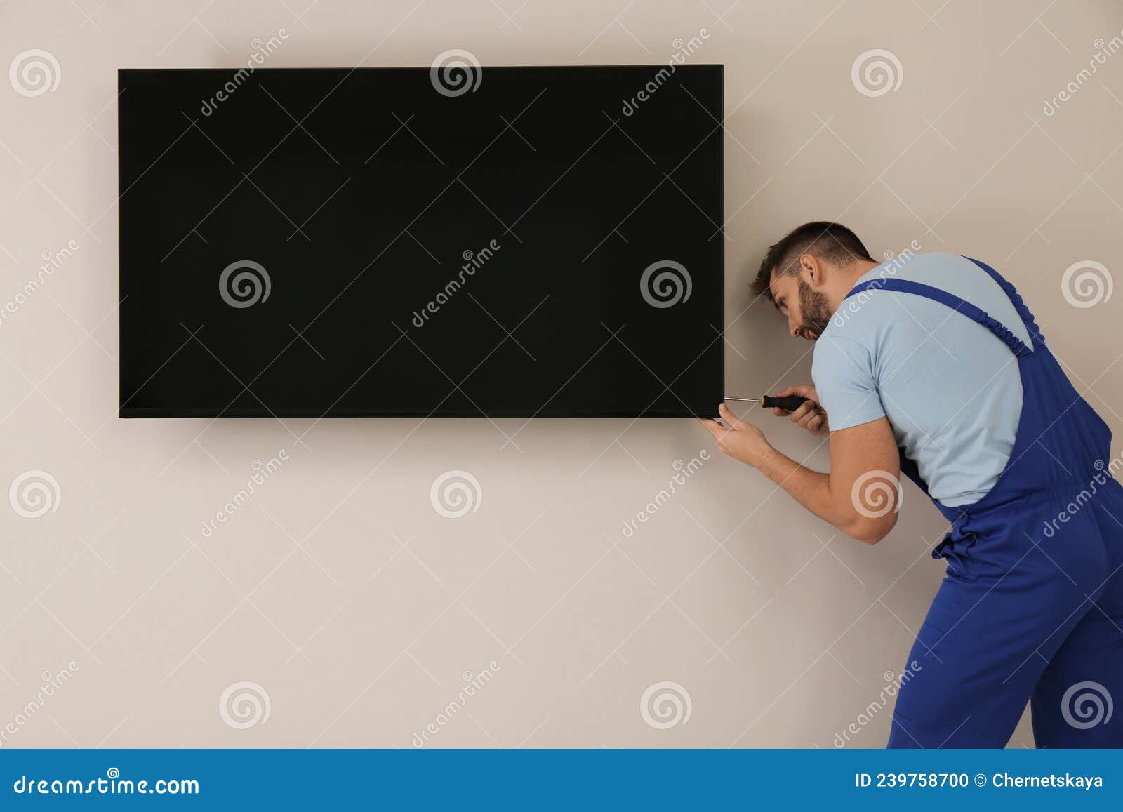 Professional Technician with Screwdriver Installing Modern Flat Screen ...
