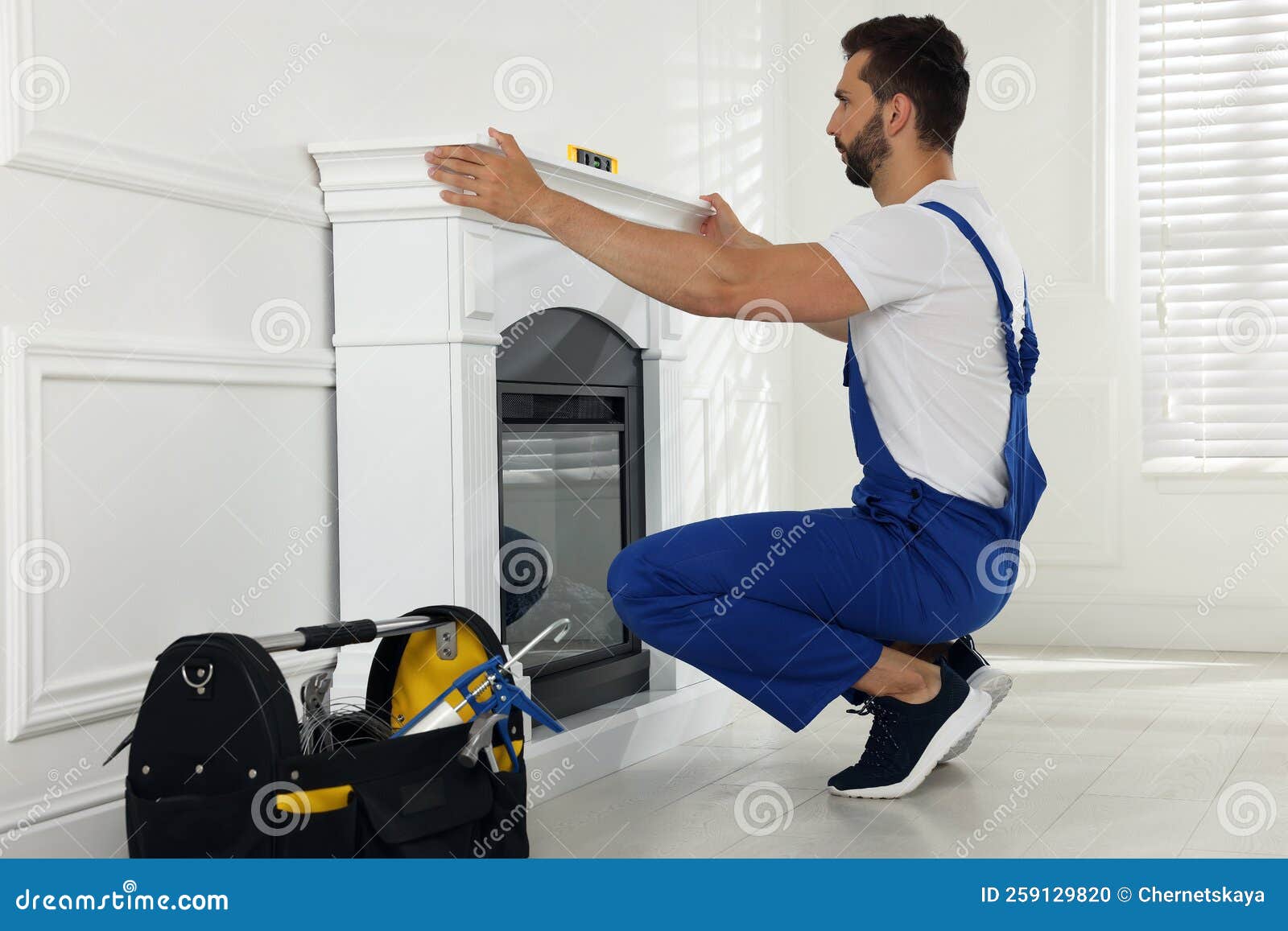 Professional Technician Using Construction Level for Installing ...