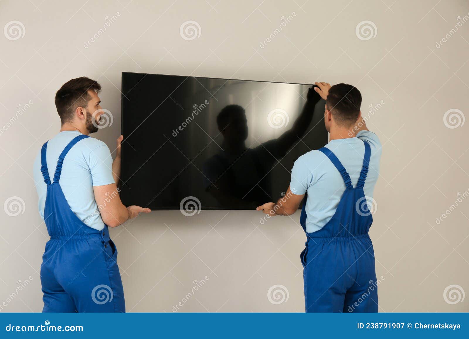 Professional Technicians Installing Modern Flat Screen TV on Wall ...