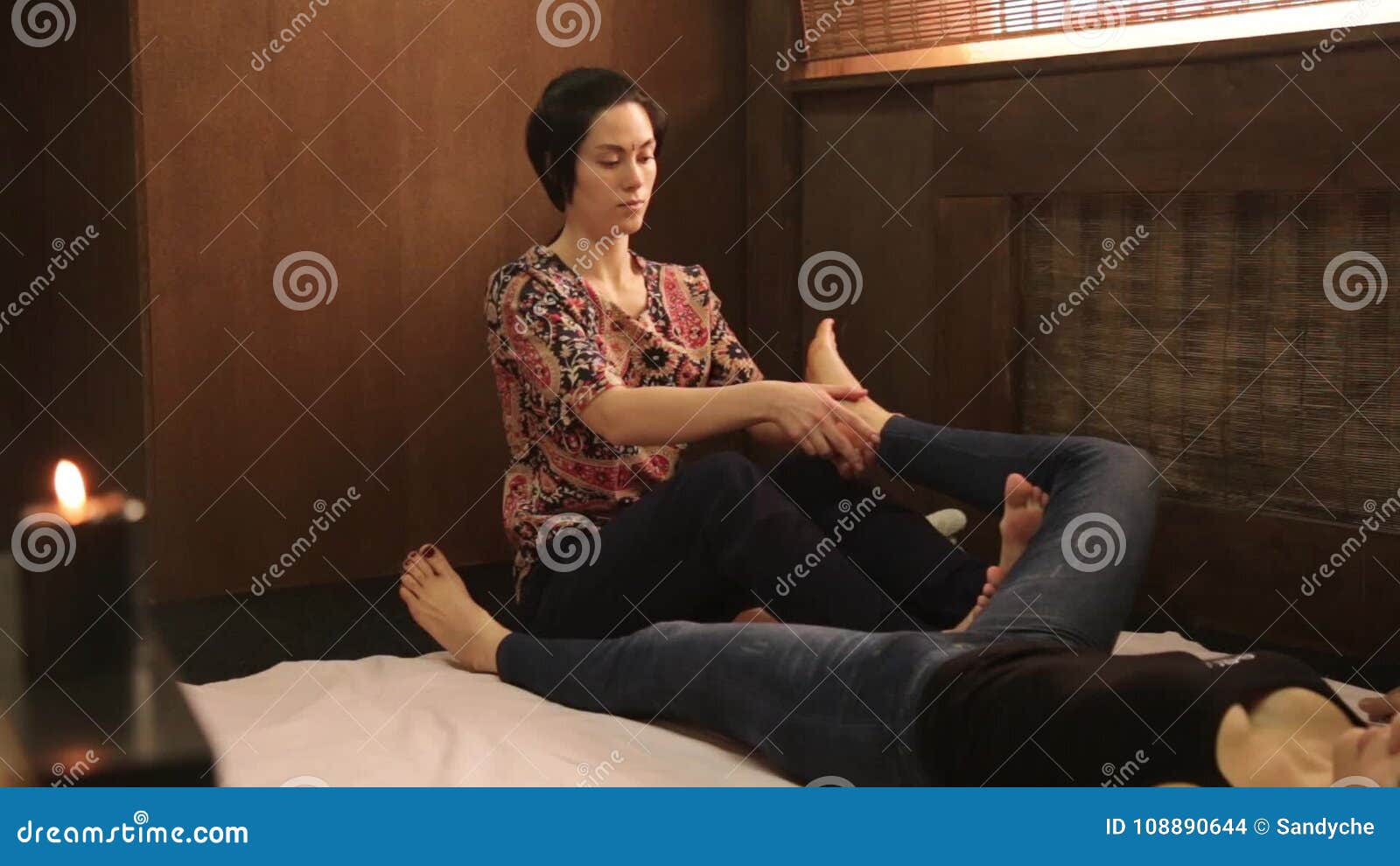 Professional Therapist Giving Traditional Thai Massage Or Thai Yoga