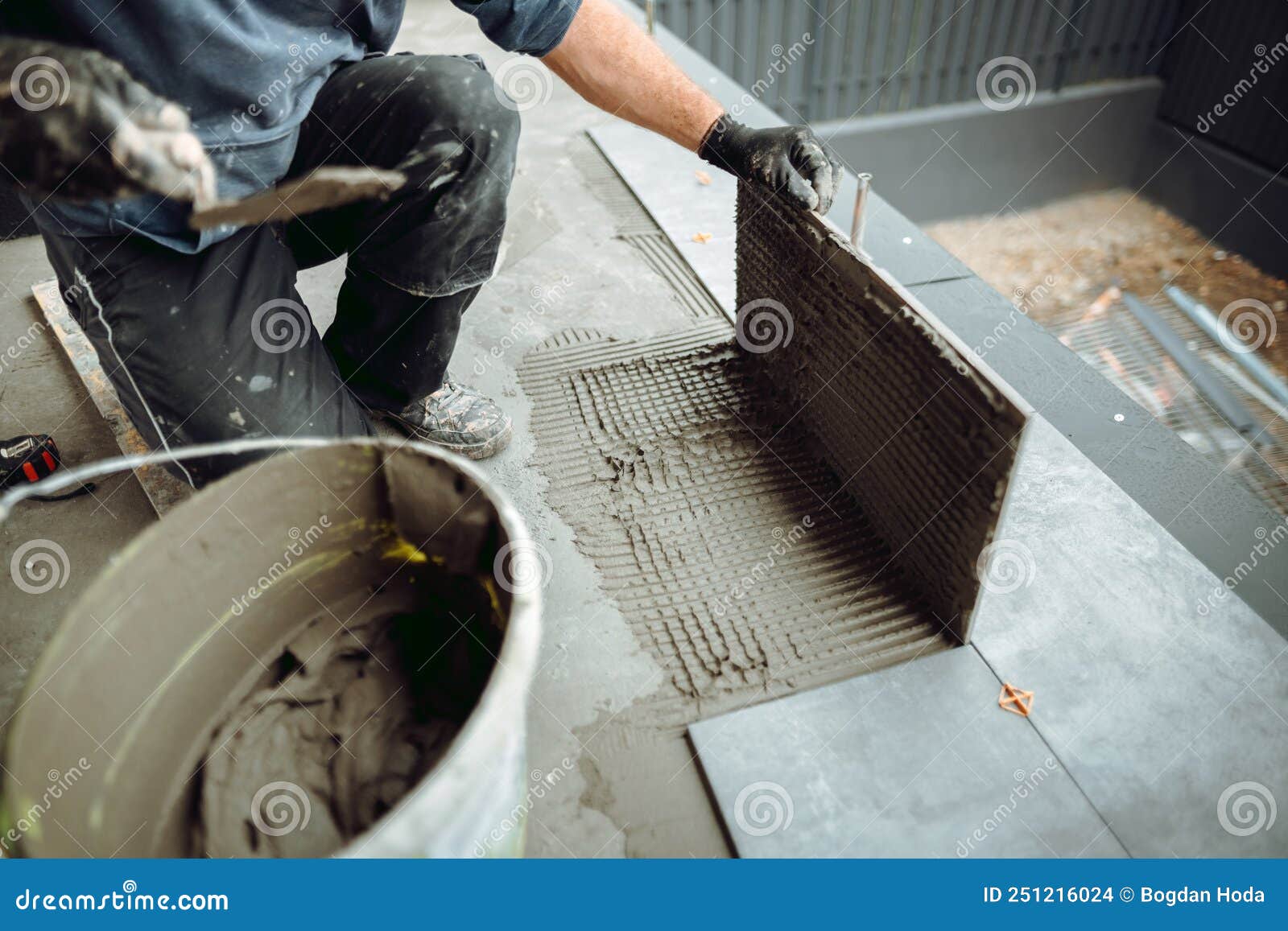 Professional Tiler and Ceramic Tiles Worker on Construction Site. Stock ...