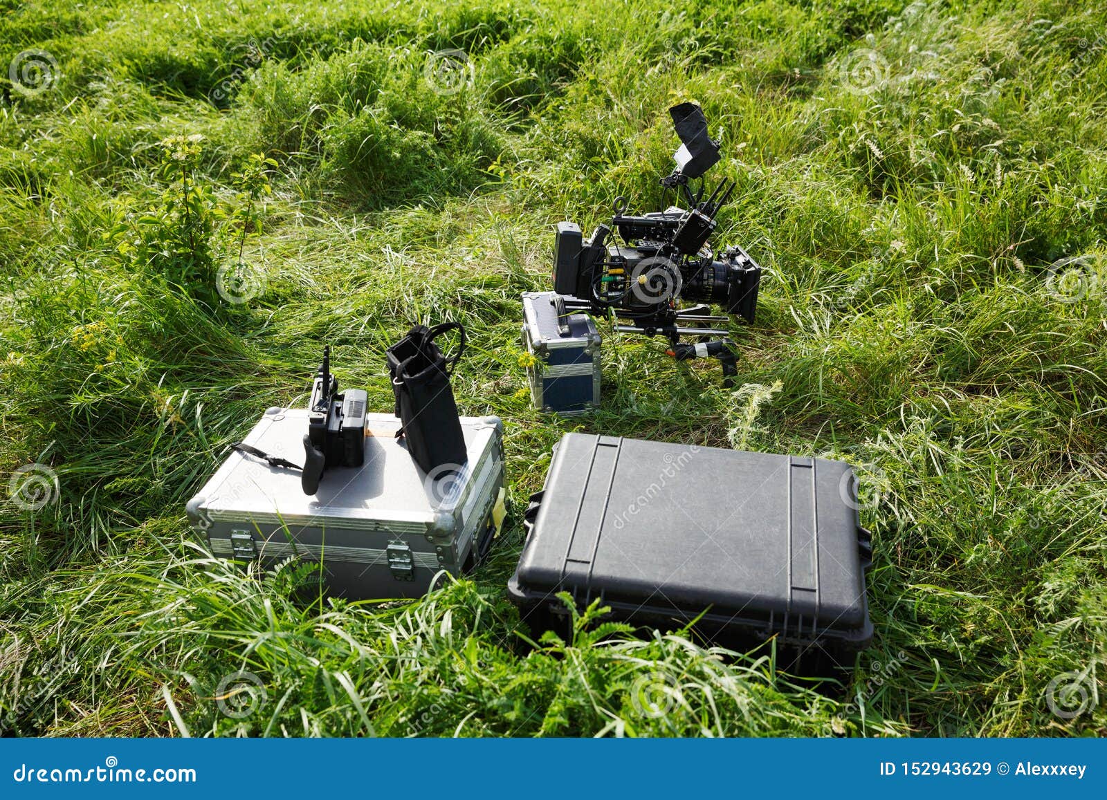 Professional Video Camera Lying on the Grass with a Suitcase for Optics ...