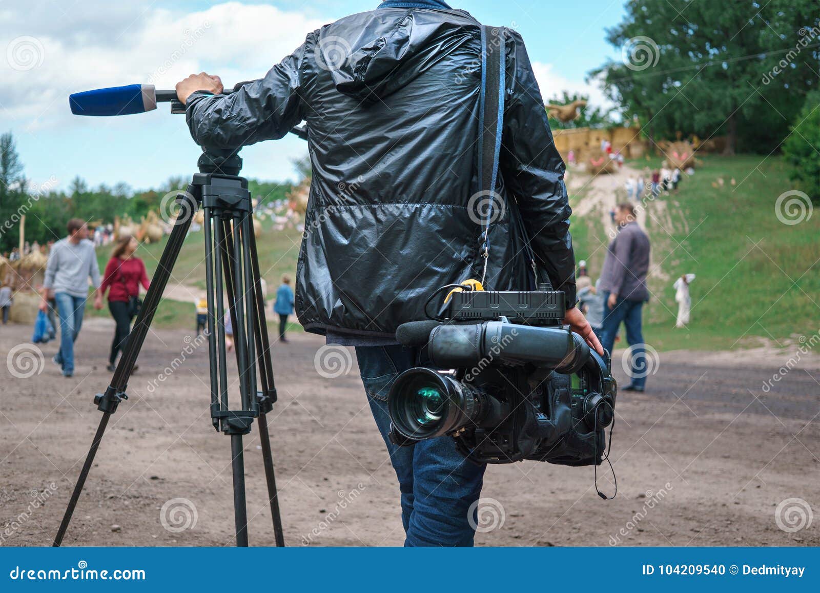 Professional Video Operator or Videographer Standing with Tripod and ...