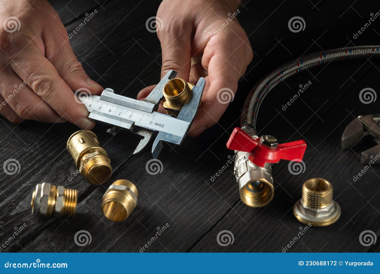 Professional Wizard Measures the Size of Fitting Using a Caliper before ...