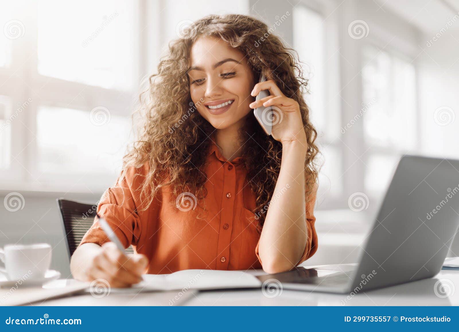 Professional Woman Multitasking, Using Phone and Writing Notes Stock ...