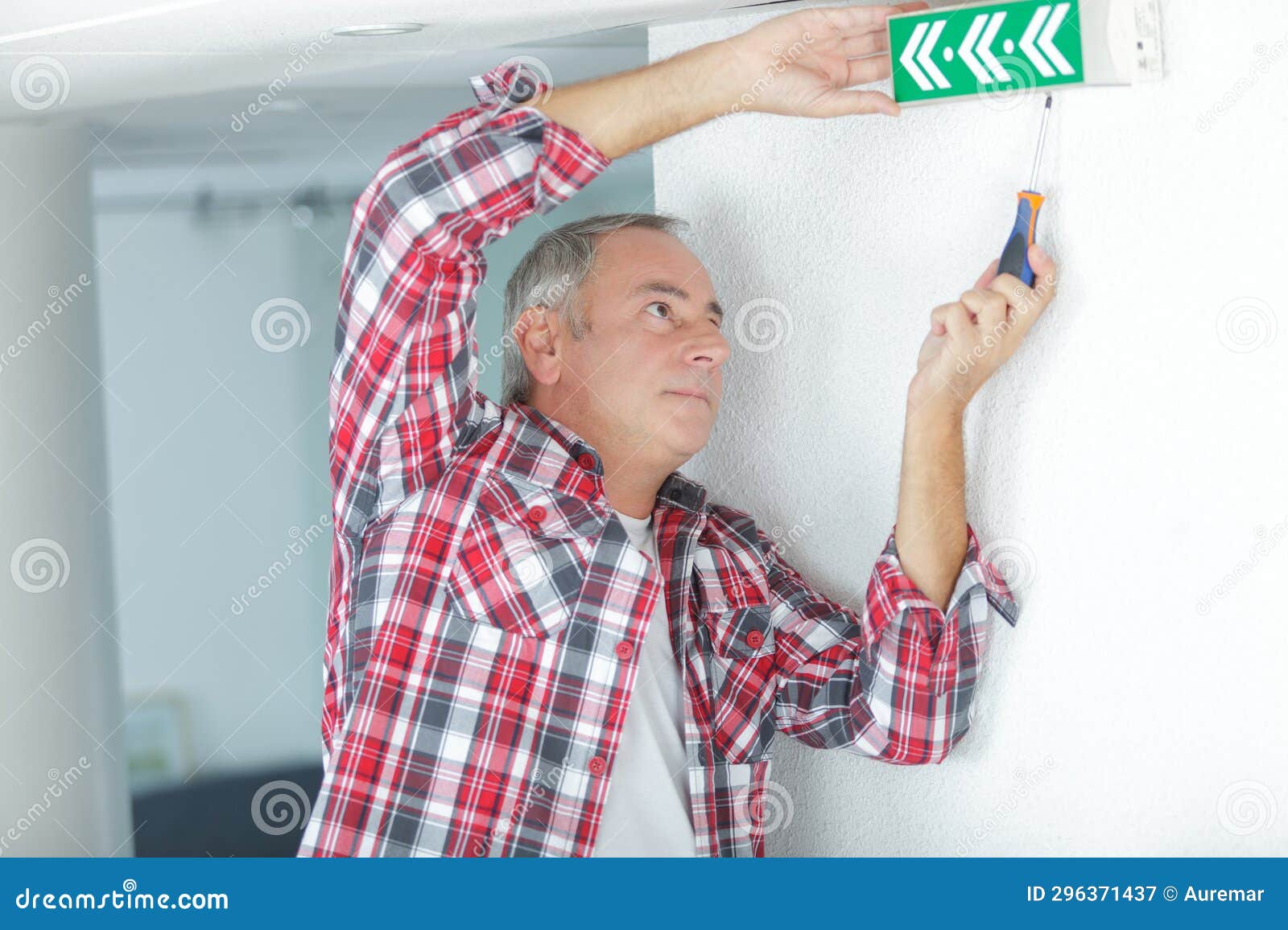Professional Worker Checking Exit Sign Stock Image - Image of ...