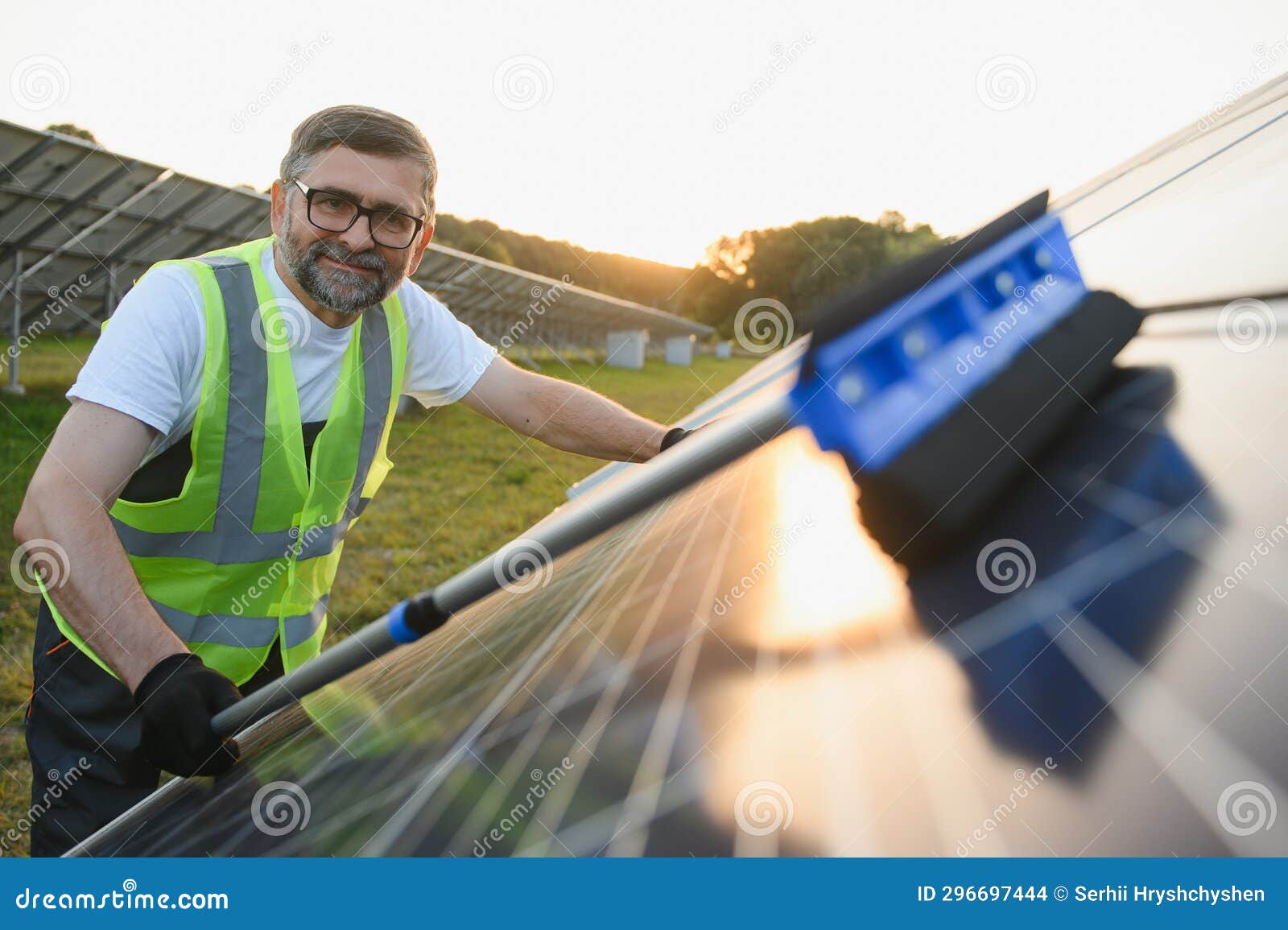 Professional Worker Cleaning Solar PV Panel. Man Making Sure Solar ...