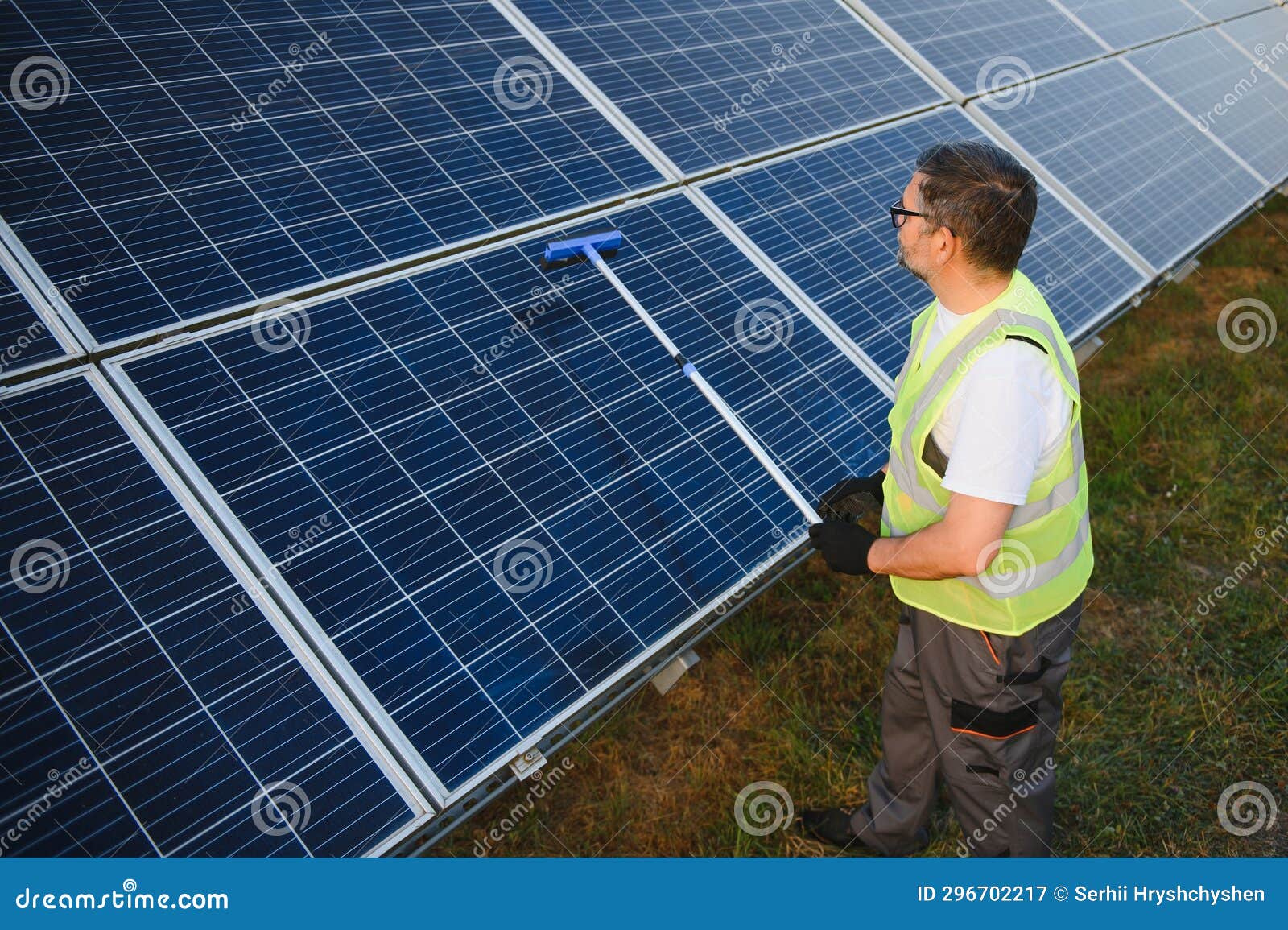 Professional Worker Cleaning Solar PV Panel. Man Making Sure Solar ...