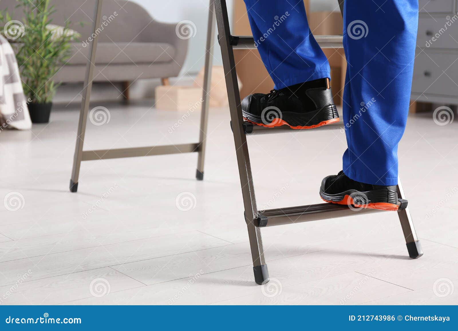 Professional Worker Climbing Up Ladder in Room, Closeup Stock Photo ...
