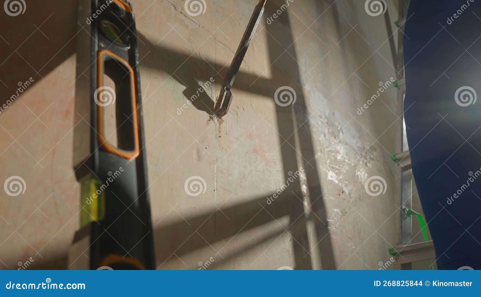 Professional Worker Getting Ready To Do a Strobe in the Wall Using a ...