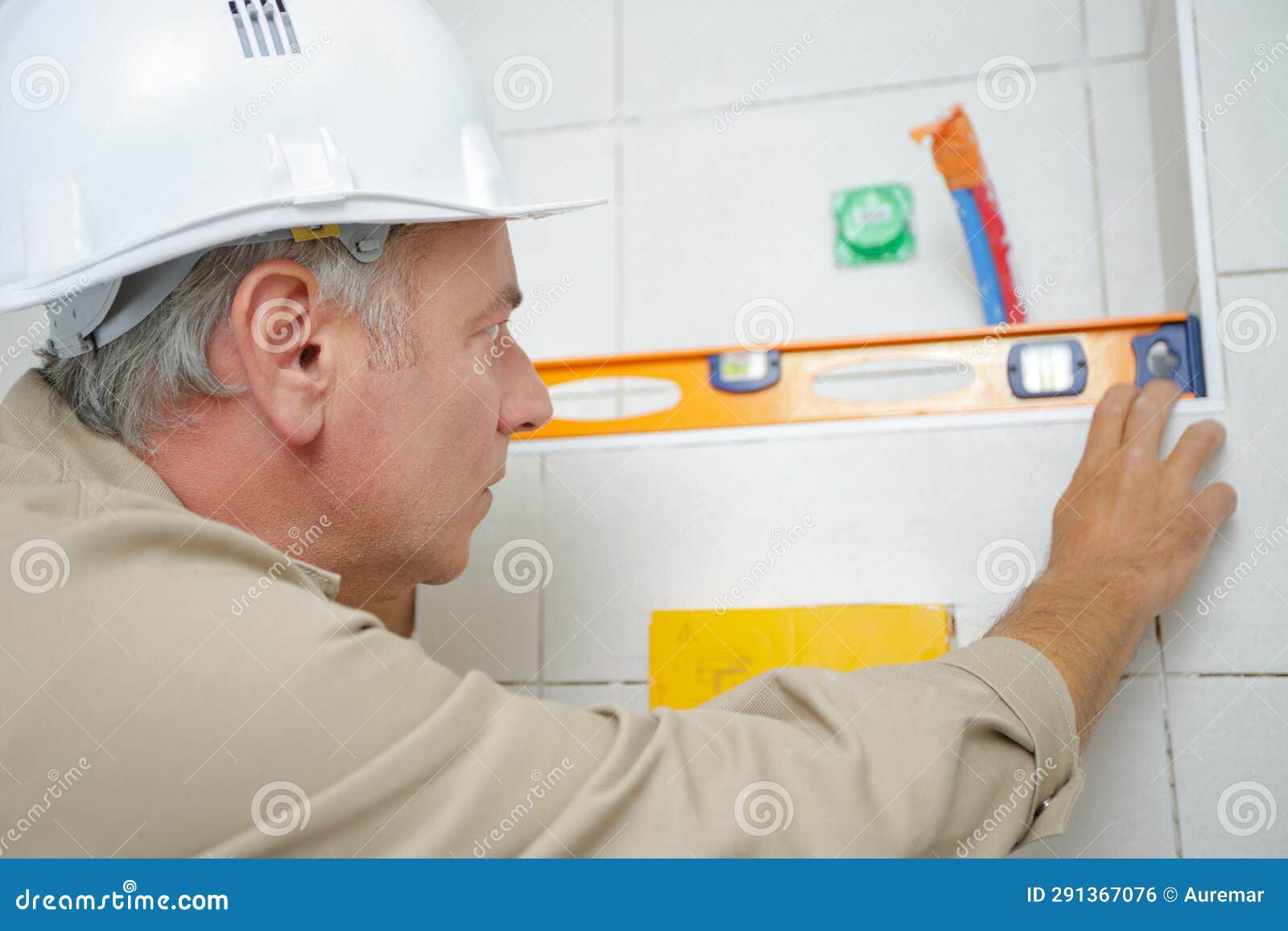 Professional Worker in Helmet Measuring Wall with Level Stock Photo ...