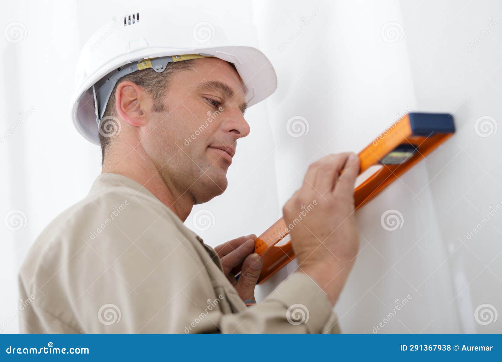 Professional Worker in Helmet Measuring Wall with Level Stock Photo ...