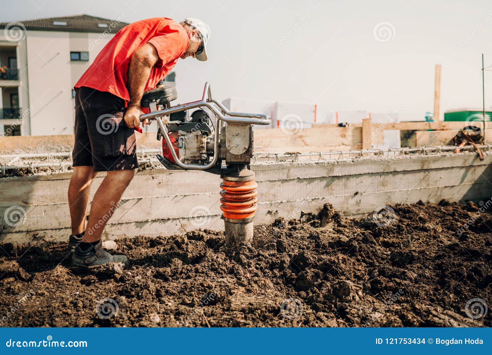 Worker, Industry Details. Worker Using Vibratory Compactor at House ...